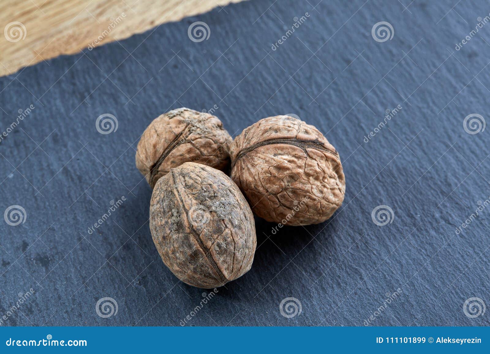 A Stack Of Hard Shells Of Walnuts Piled Together On Dark Piece Of Wood ...