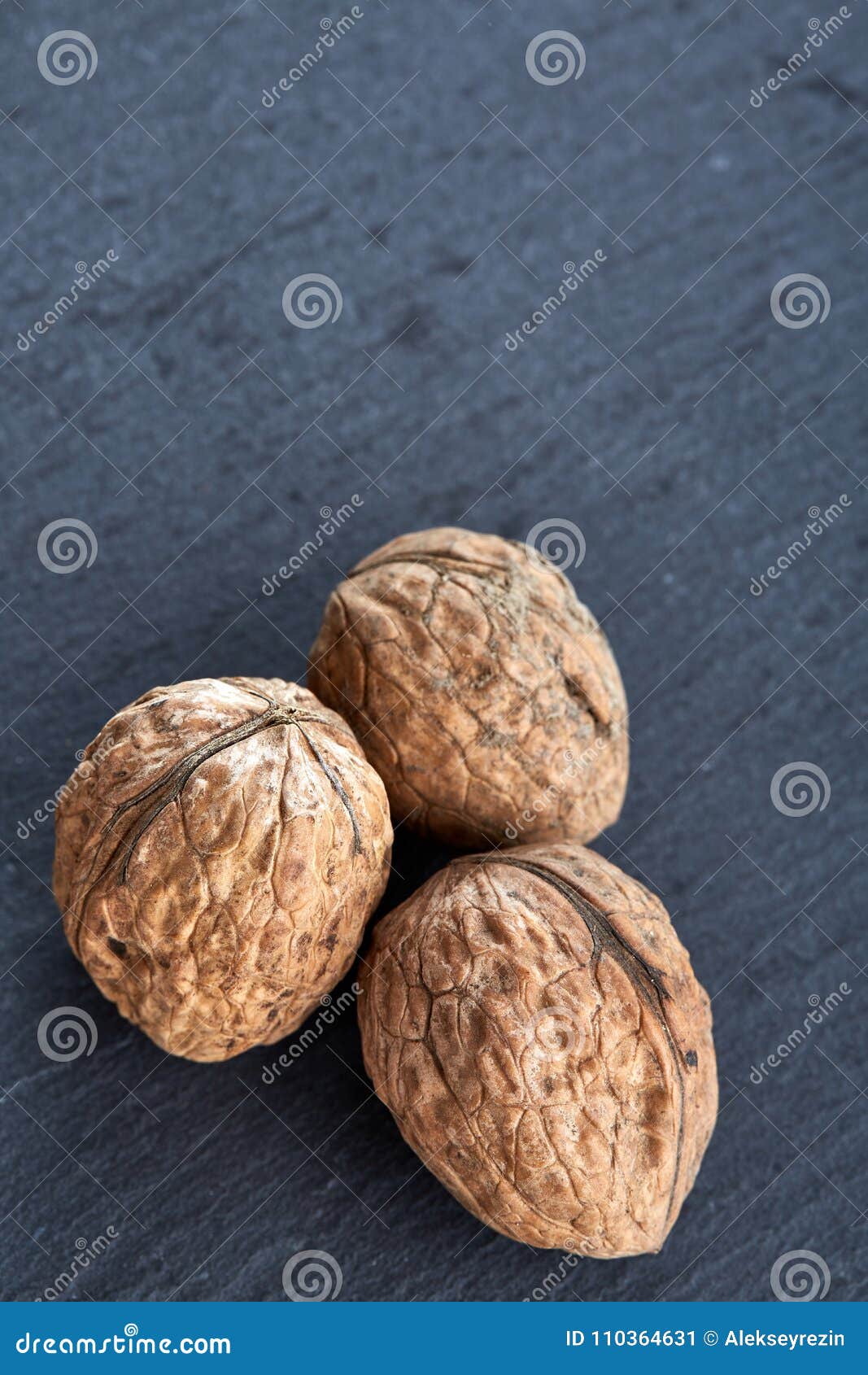 A Stack of Walnuts Piled Together and Isolated on Dark Background ...