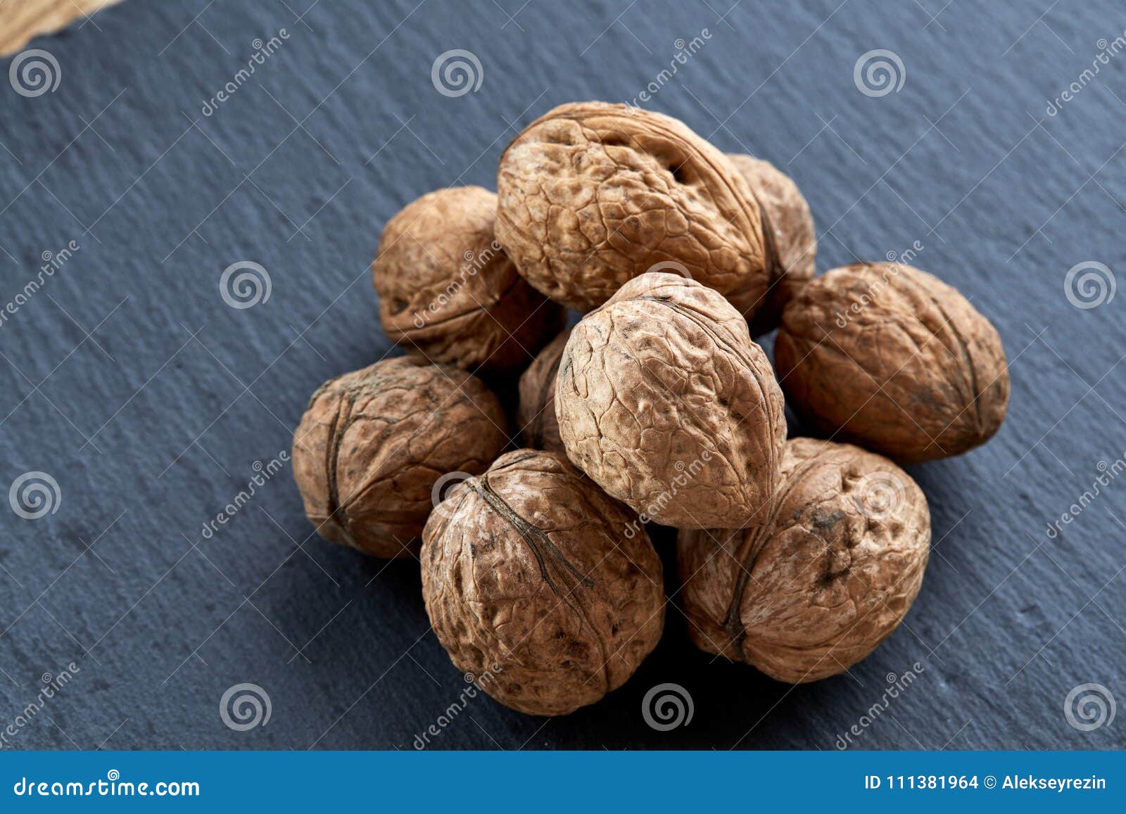 A Stack of Walnuts Piled Together and Isolated on Dark Background ...