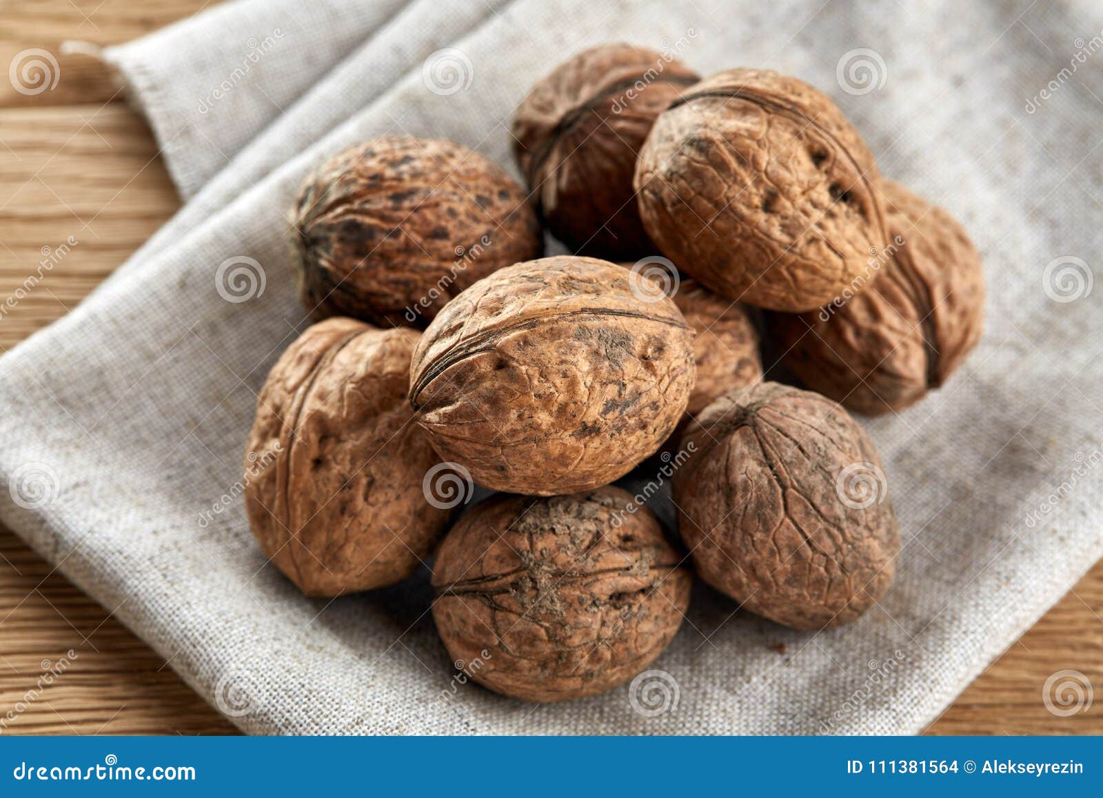 A Stack of Walnuts Piled Together and on Rustic Wooden Background ...