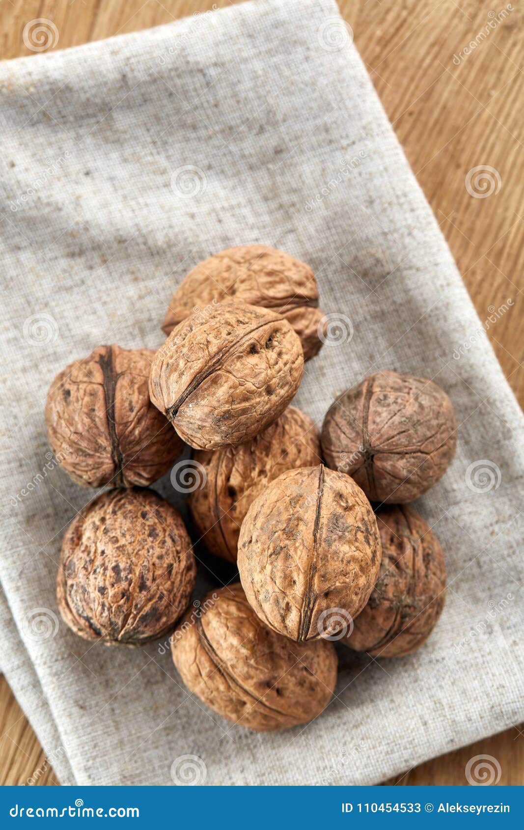 A Stack of Walnuts Piled Together and on Rustic Wooden Background ...