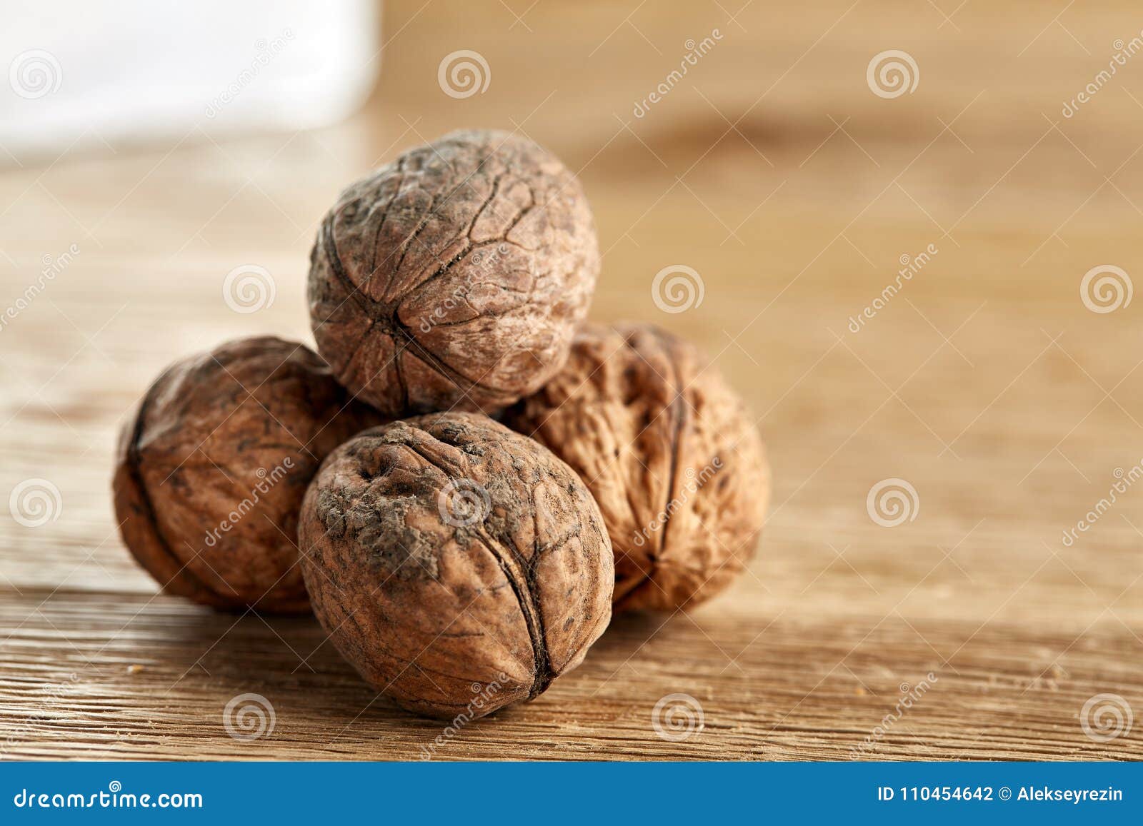 A Stack of Walnuts Piled Together and on Rustic Wooden Background ...