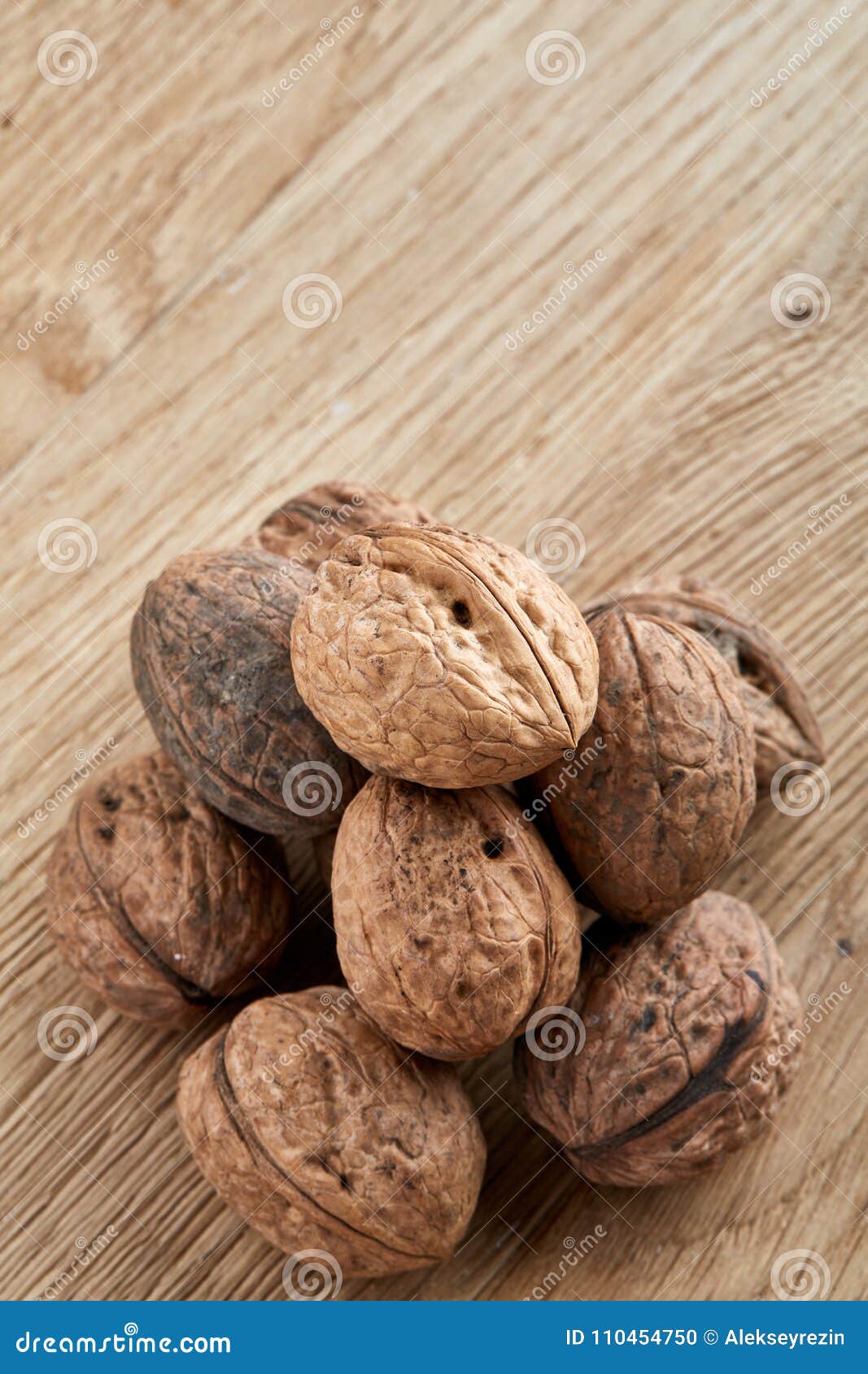 A Stack of Walnuts Piled Together and on Rustic Wooden Background ...