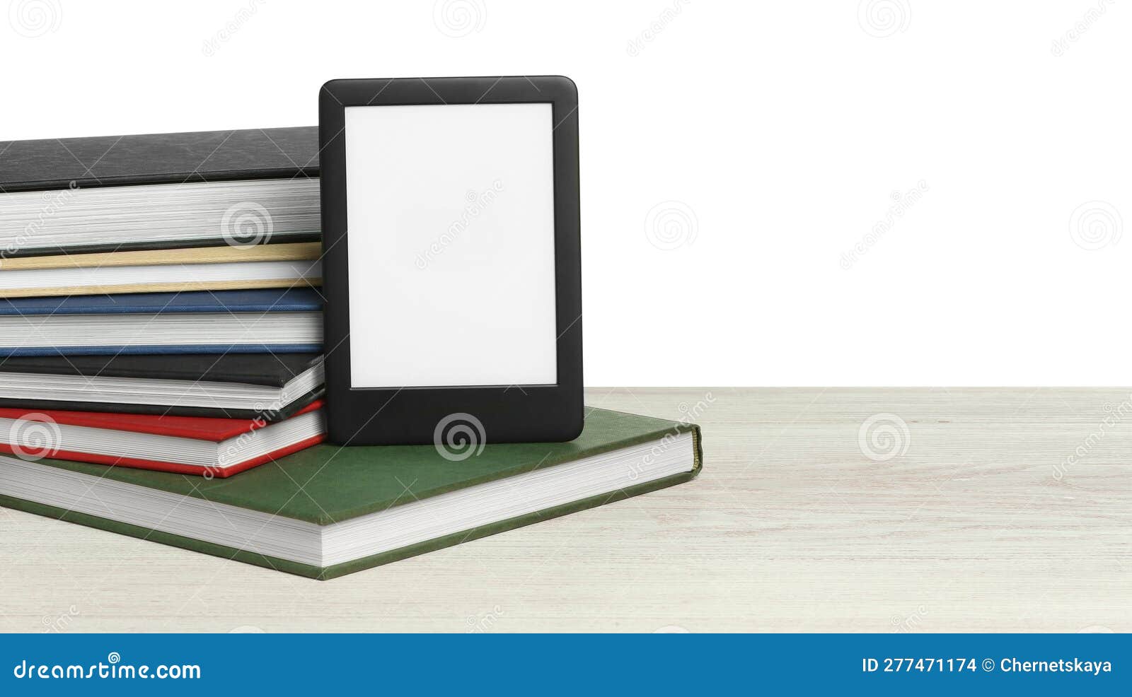 Stack of Hardcover Books and Modern E-book on Wooden Table Against ...