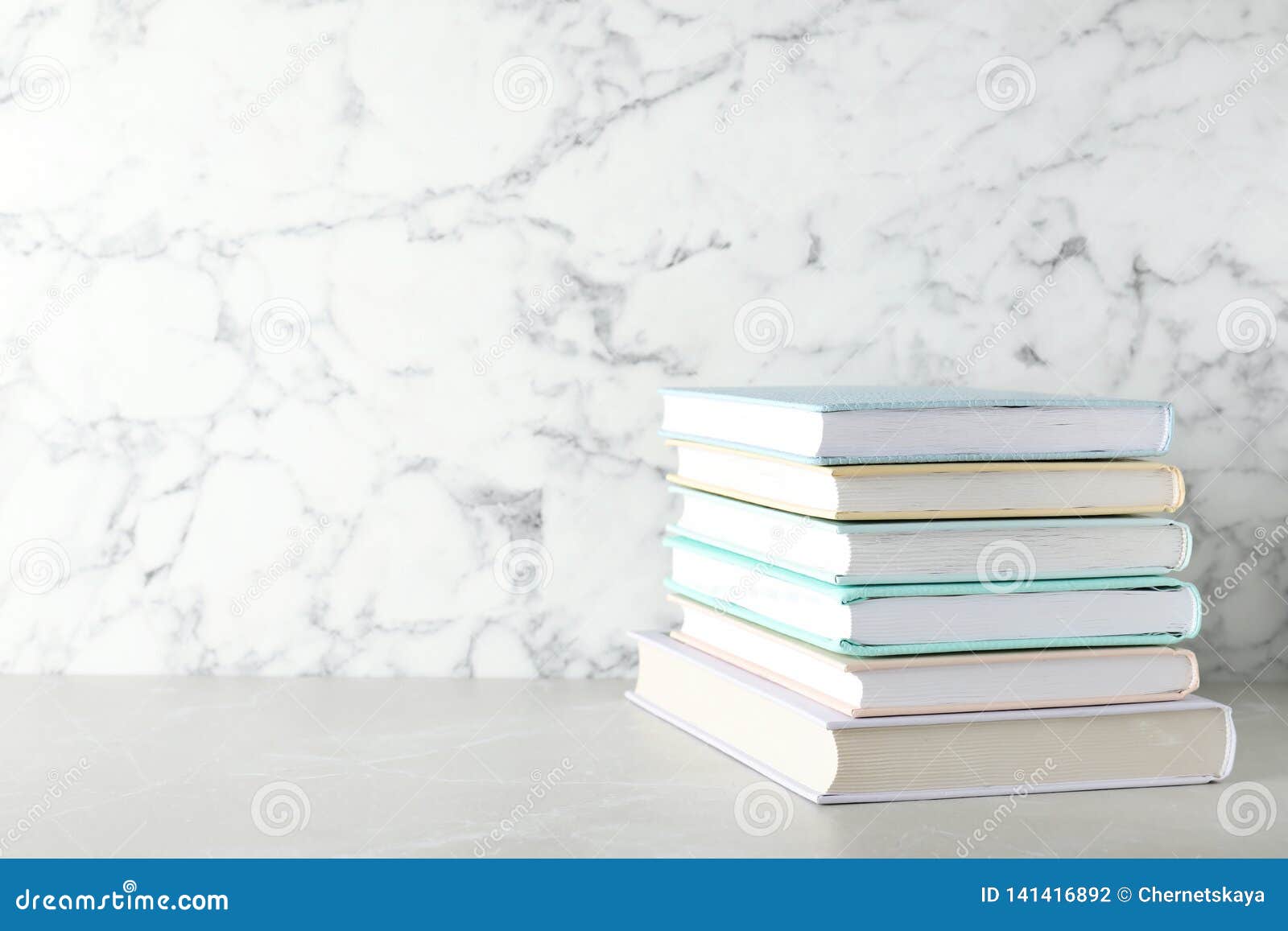 Stack of Hardcover Books on Table Against Marble Background Stock Photo ...