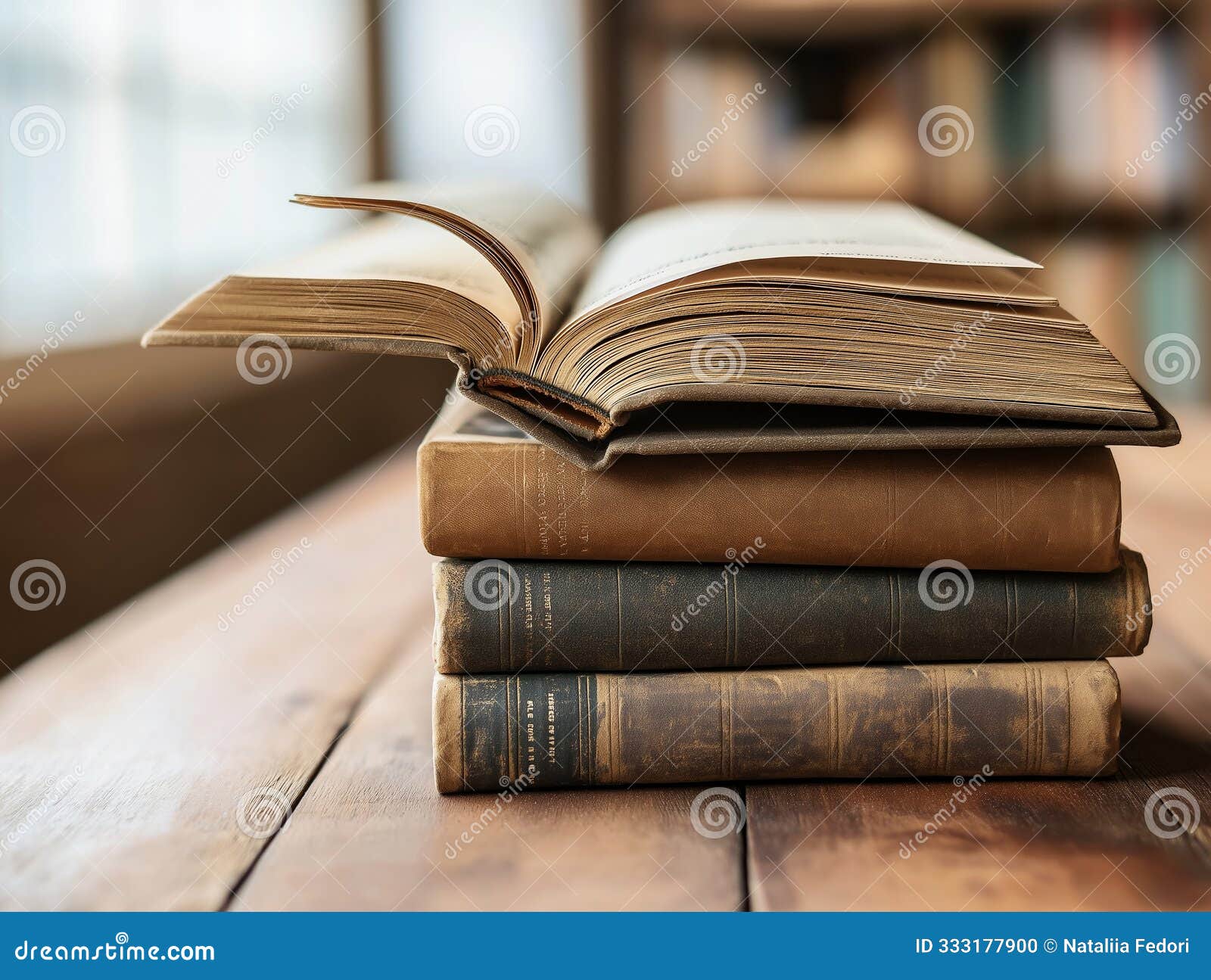 A Stack Of Hardcover Books On A Wooden Table, With The Spines Facing ...