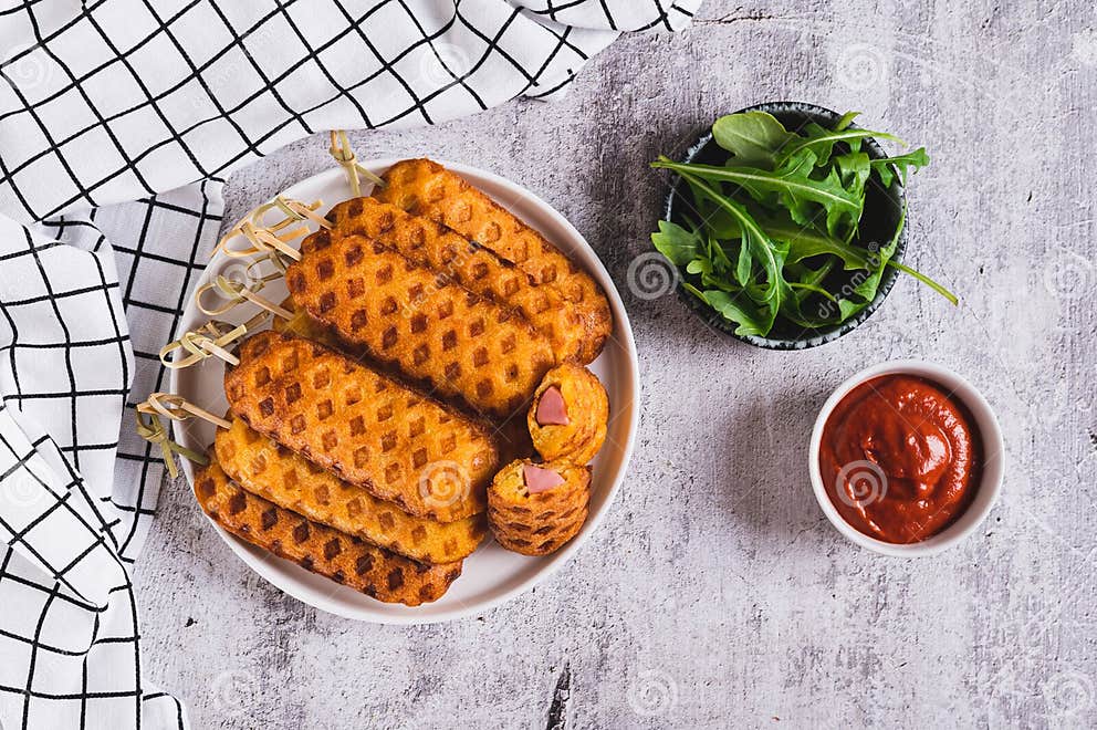Stack of Homemade Corn Dogs with Sausage on a Plate on a Table Top View ...