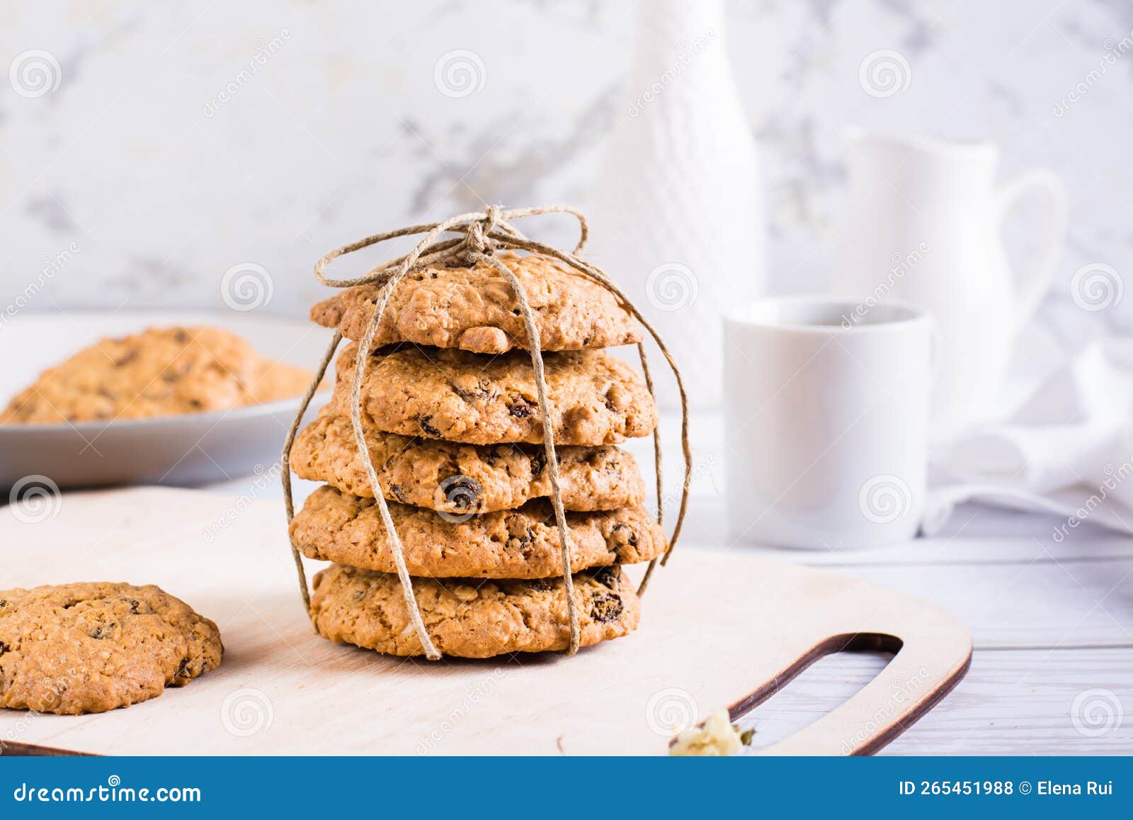 A Stack of Homemade Oatmeal Raisin Cookies Tied with String on a Board ...