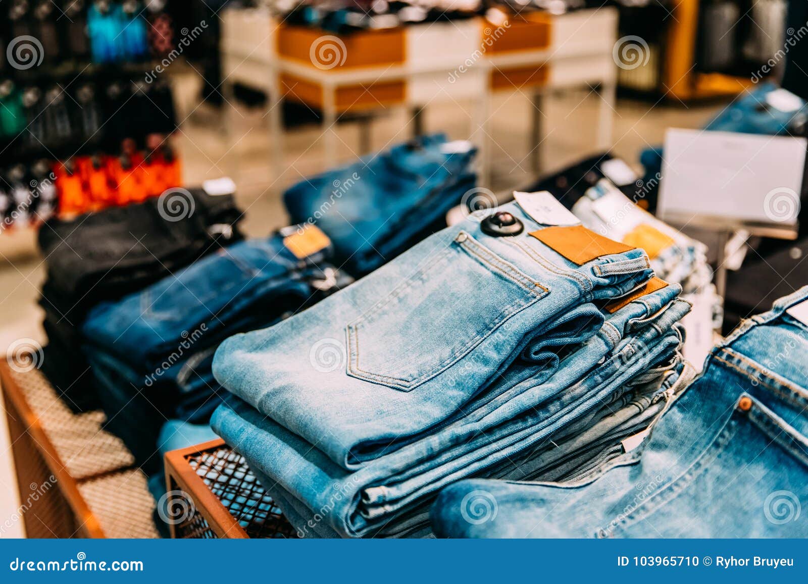 Stack of Jeans on Shelves in Store of Shopping Center Stock Photo ...