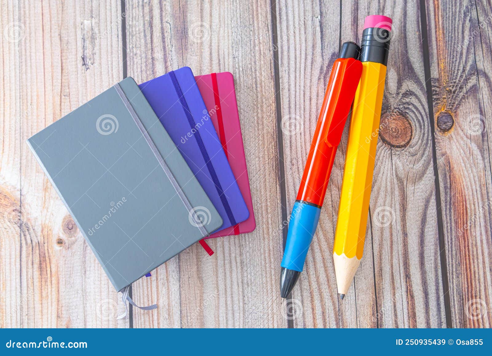 Stack of Journals Notebooks with Giant Pen and Pencil Stock Image ...