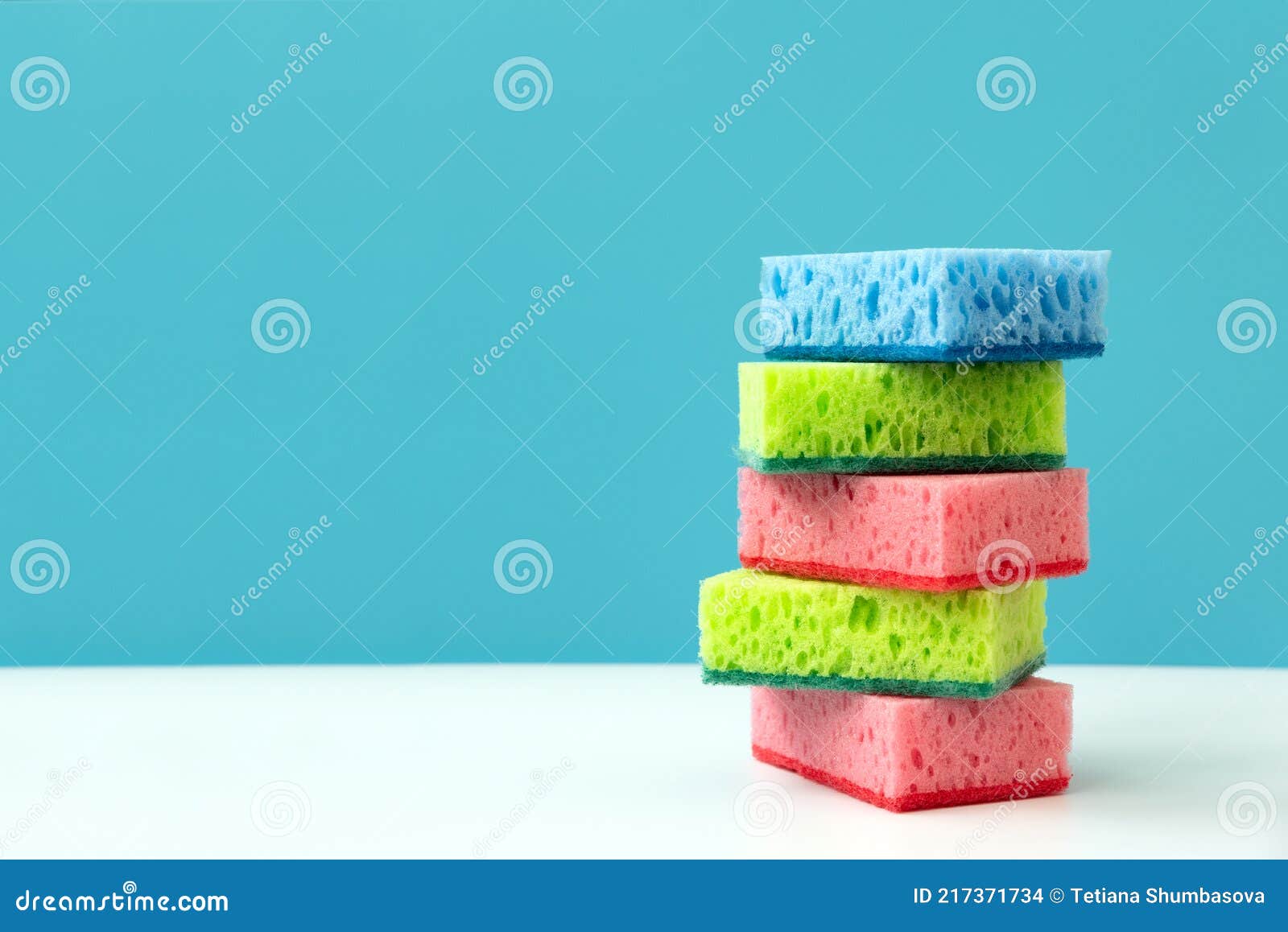 Stack of Kitchen Cleaning Sponges on Blue Background. Front View Stock ...