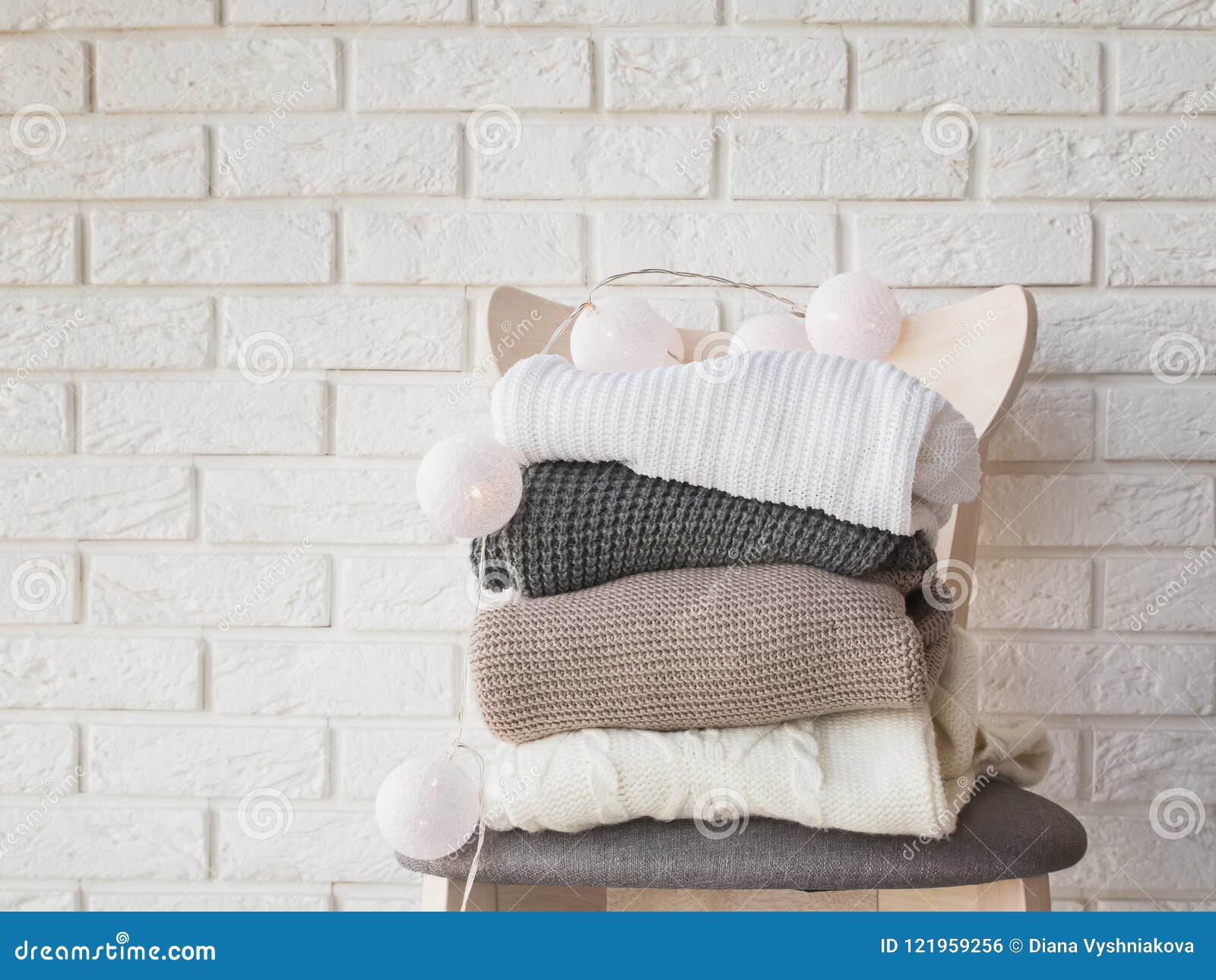 Stack of Knitted Sweaterson the Brick Wall Background Stock Photo ...