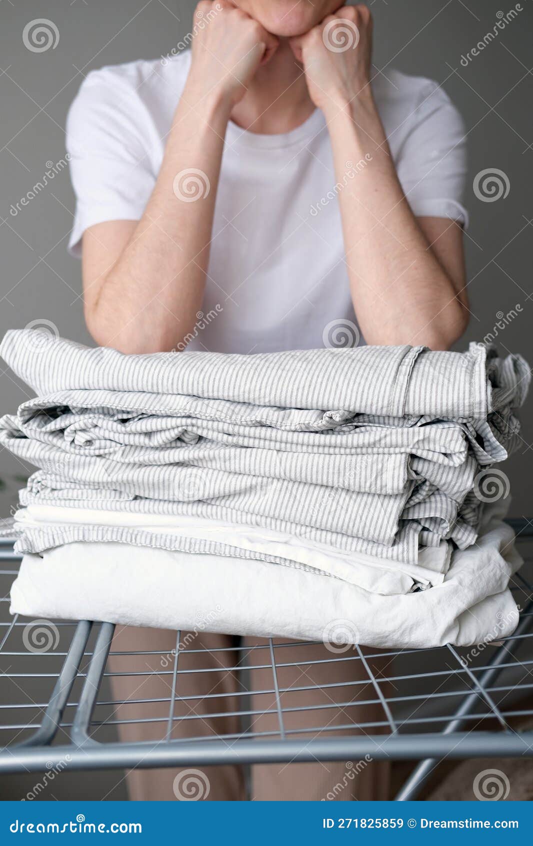 Stack of Laundry and Woman Folding Clean Bedding and Clothes Stock ...