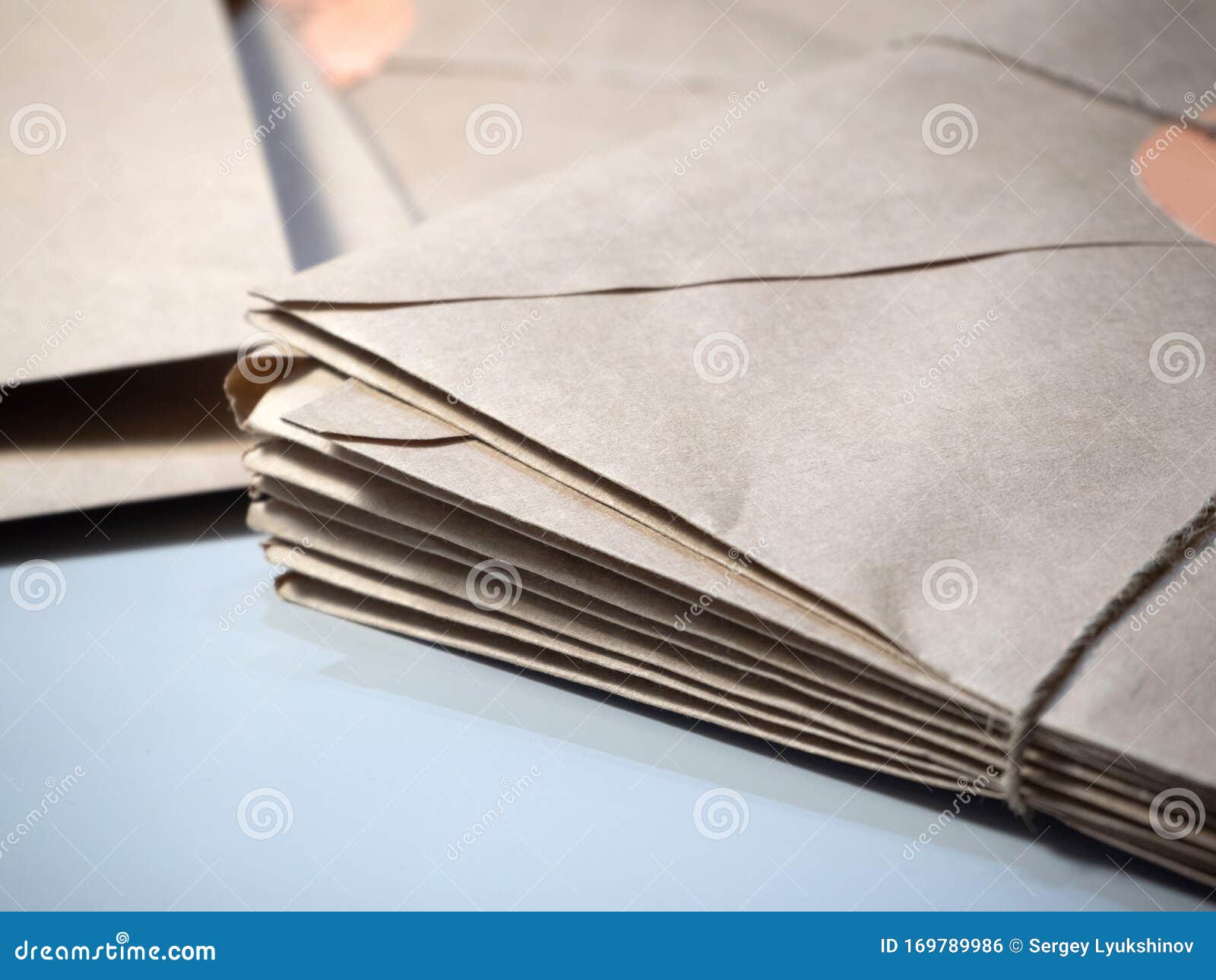 A Stack of Letters in Kraft Envelopes Lies on the Table Stock Photo ...