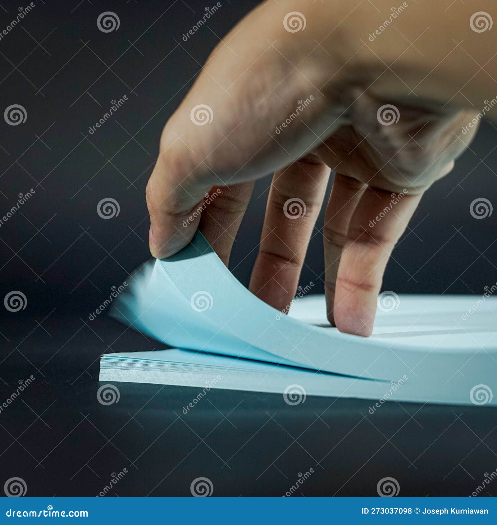 Stack of Light Blue Colored Paper with Hand on Frame Stock Photo ...