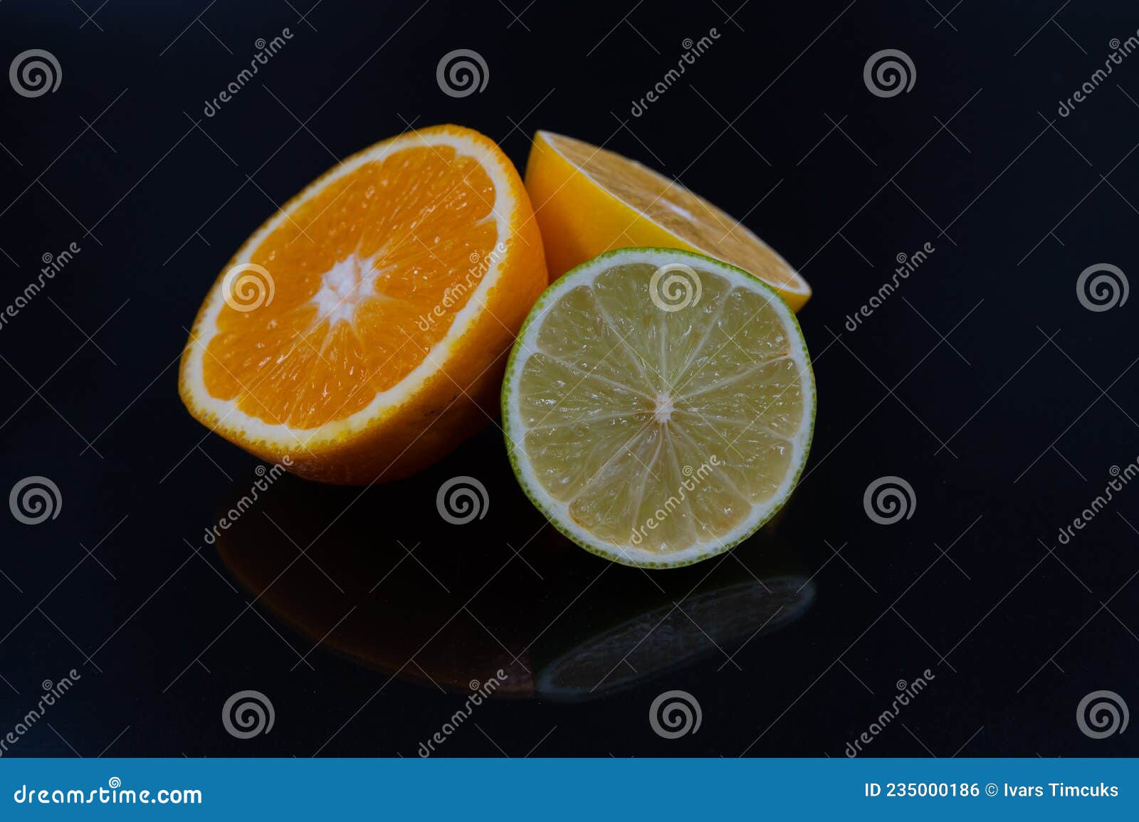 Stack of Lime, Orange and Lemon Halves on a Isolated Black Background ...