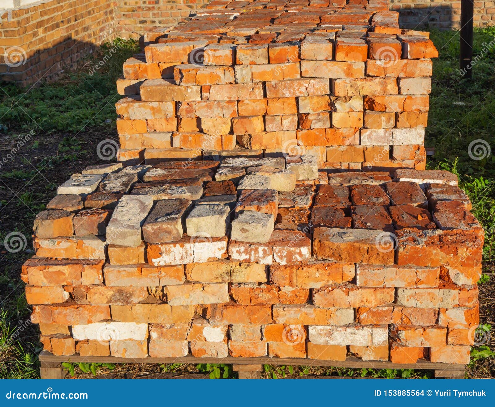 Stack of Lined Up Used Bricks on the Pallet on the Sunset Stock Photo ...