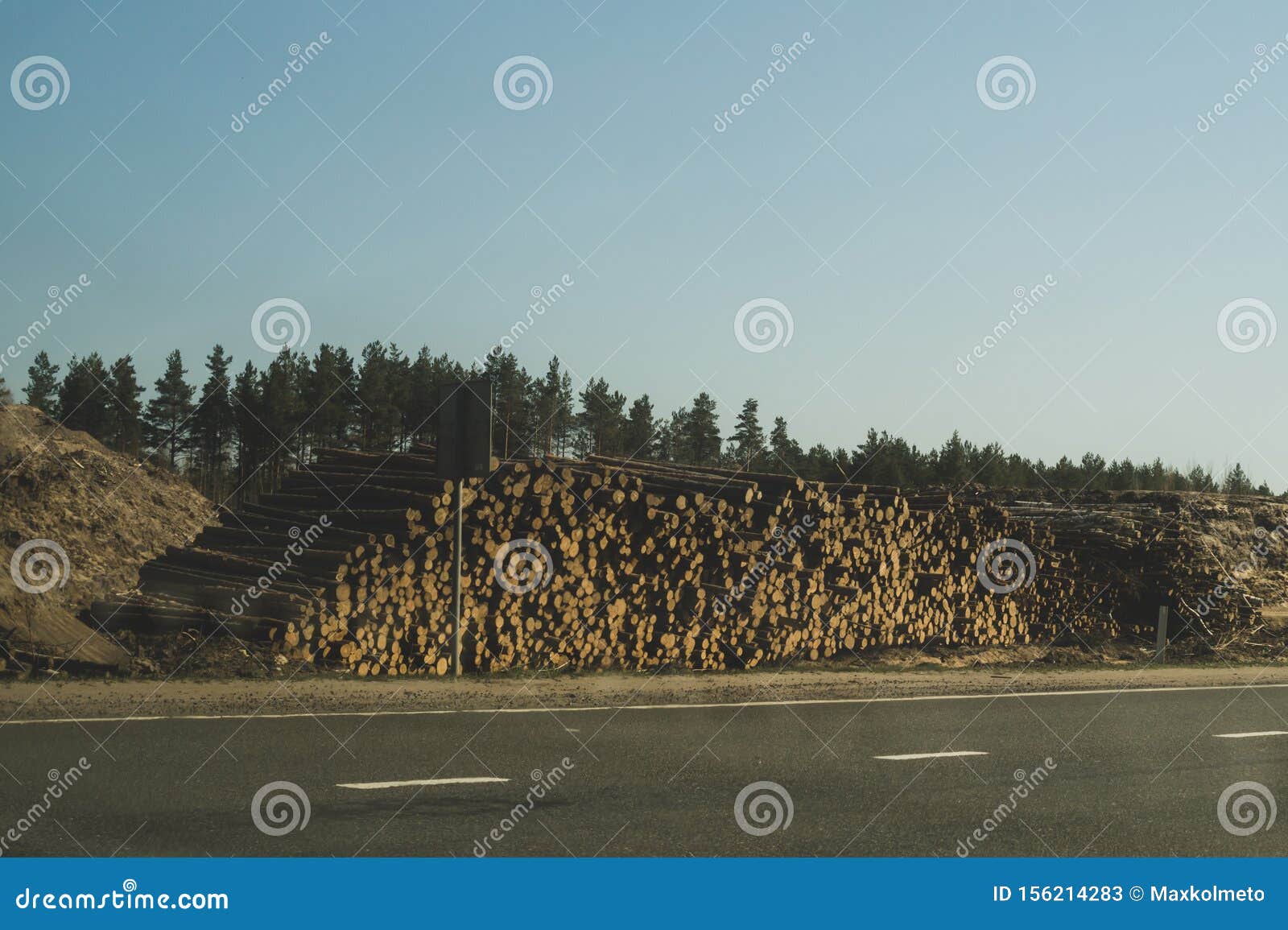 Stack of Logs Lying on the Side of the Road. Big Pile of Timber Stock ...