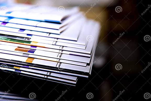 Stack of Magazines and Annual Reports on Dark Background. Isolated ...