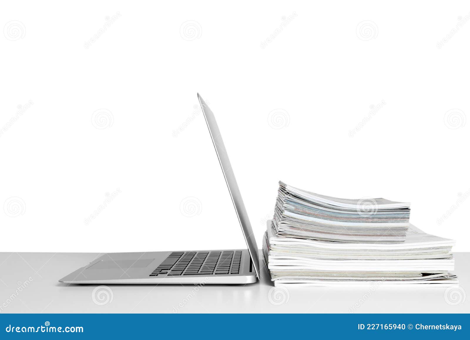 Stack of Magazines and Laptop on Table Near White Wall Stock Photo ...