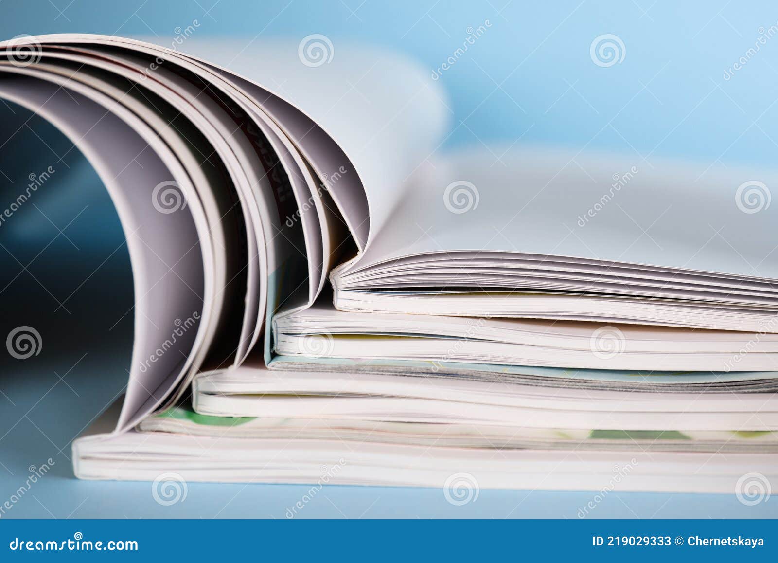 Stack of Magazines on Light Blue Background, Closeup Stock Image ...
