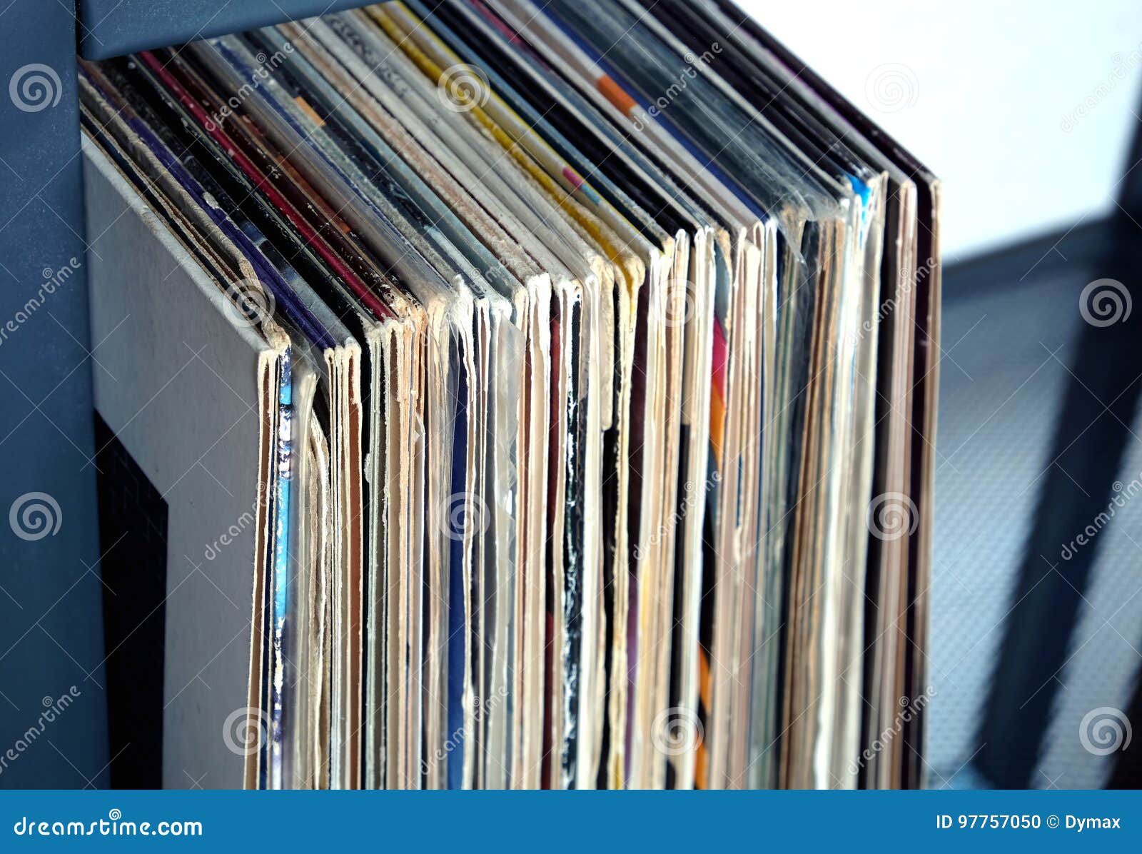 Stack of Many Vinyl Records in Old Color Covers on a Shelf Side View ...