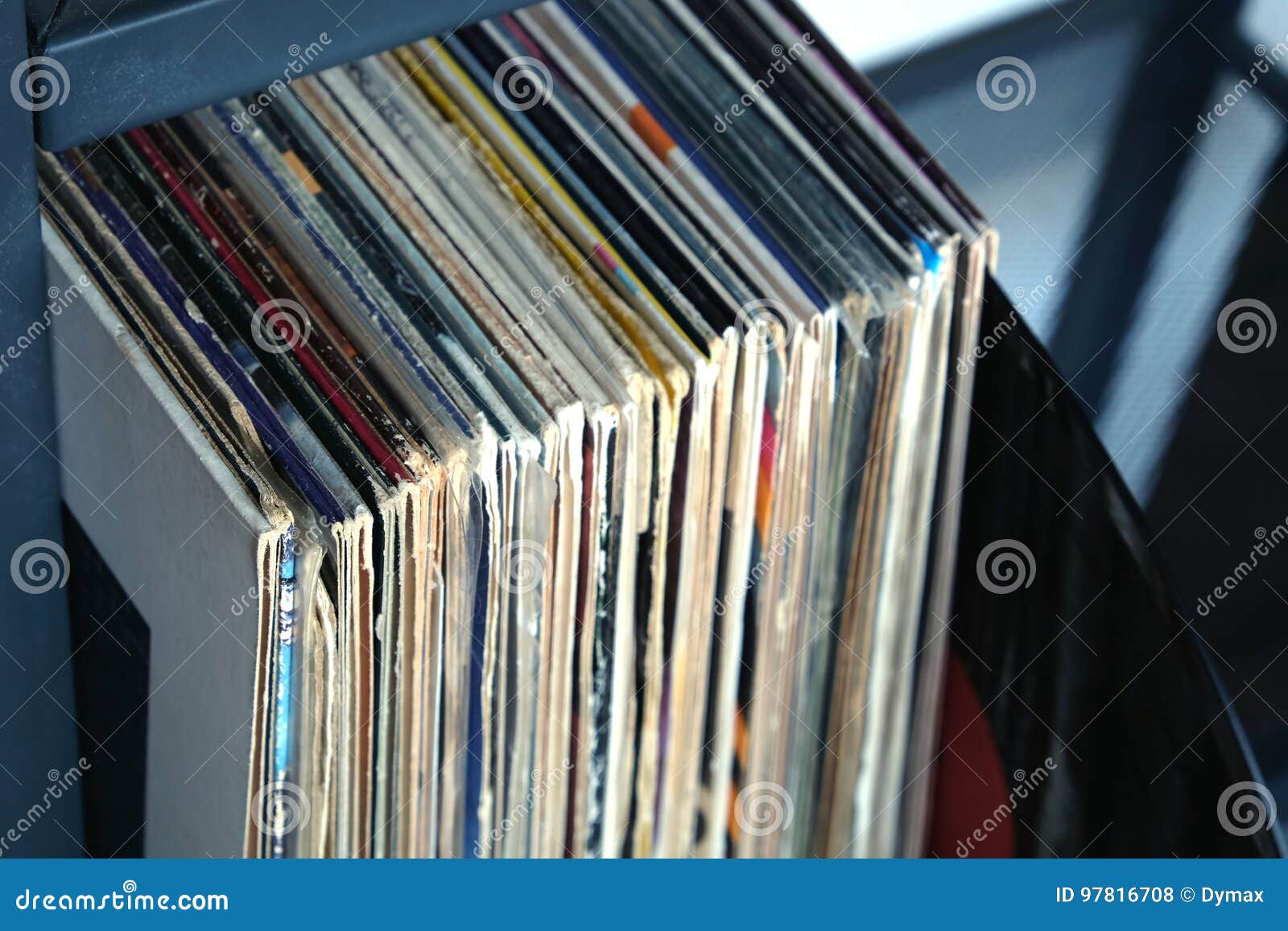 Stack of Many Vinyl Records in Old Color Covers on a Shelf Side View ...