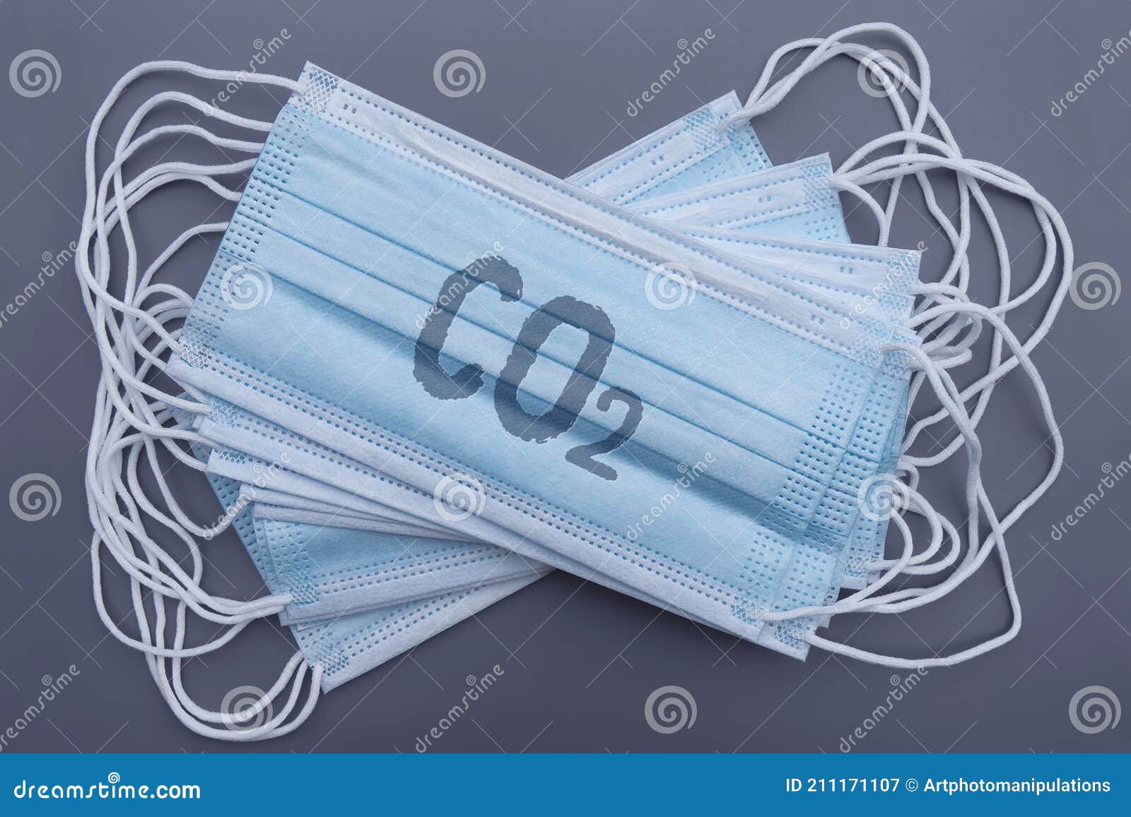 A Stack of Medical Blue Masks with a Carbon Dioxide Formula on a Gray ...