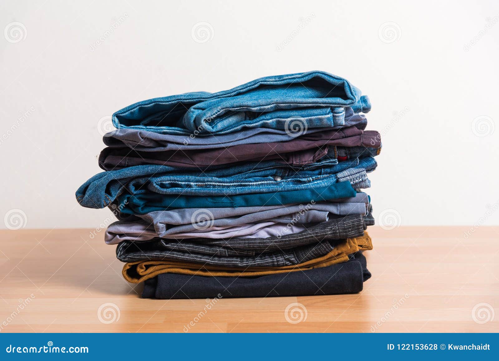 Stack of Men Pants on Wood Table Stock Photo - Image of fashion, stack ...