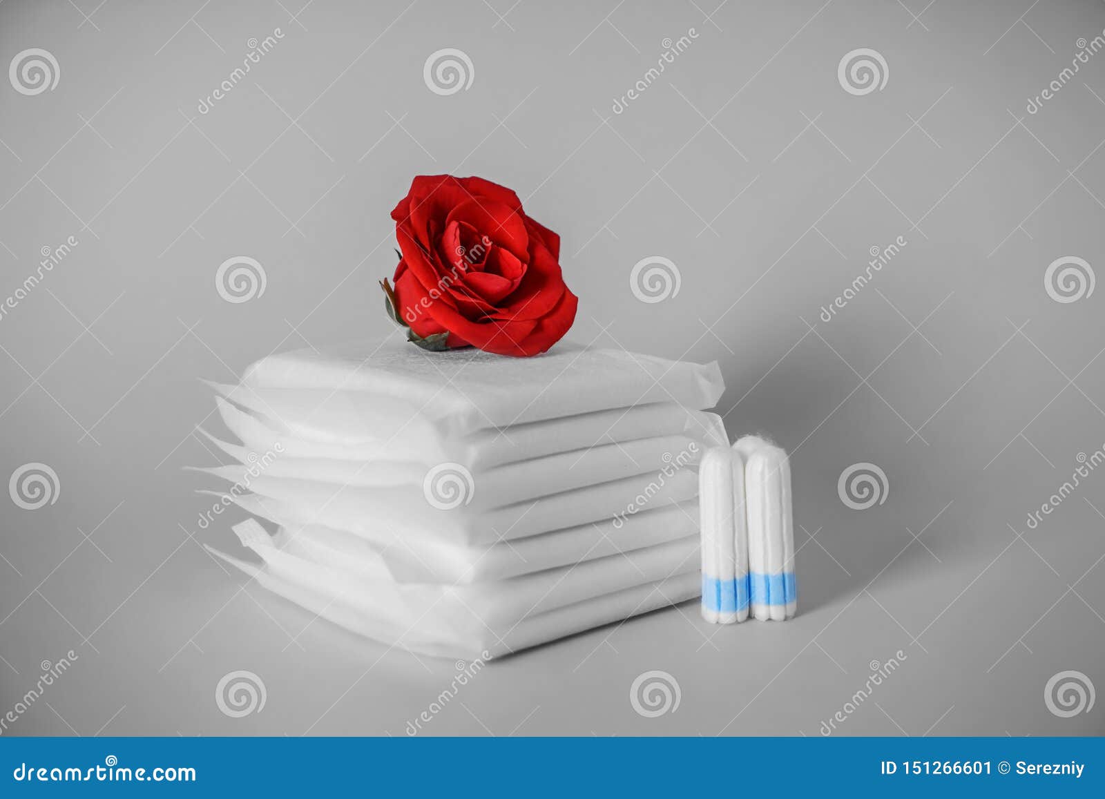 Stack of Menstrual Pads with Red Rose and Tampons on Grey Background ...