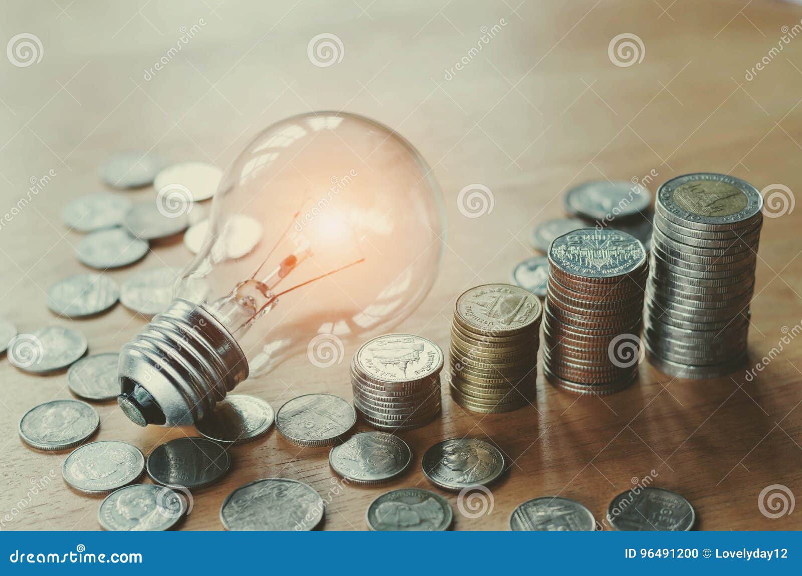 Stack Money Coins with Growing Light Bulb Stock Photo - Image of ...