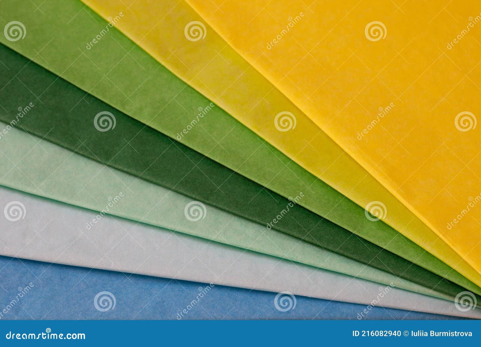 A Stack of Multi Colored Tissue Paper Spread Out in a Fan Stock Photo ...