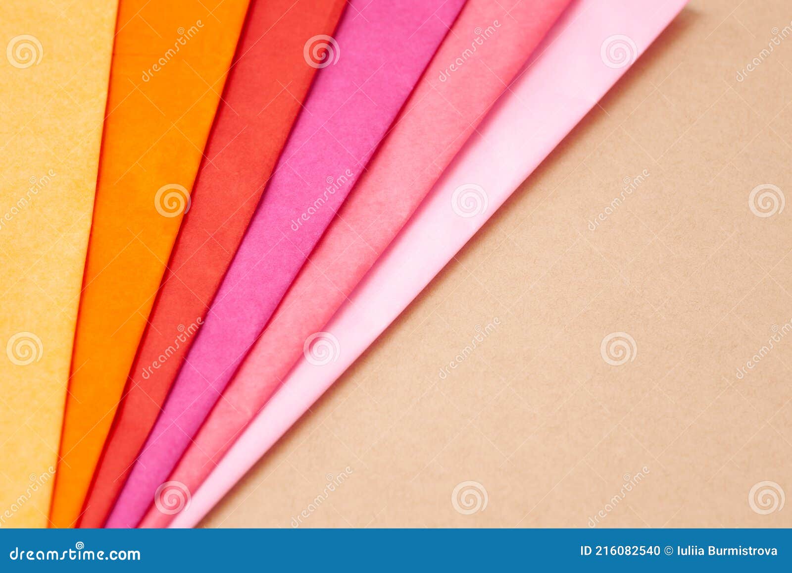 A Stack of Multi Colored Tissue Paper Spread Out in a Fan on a ...
