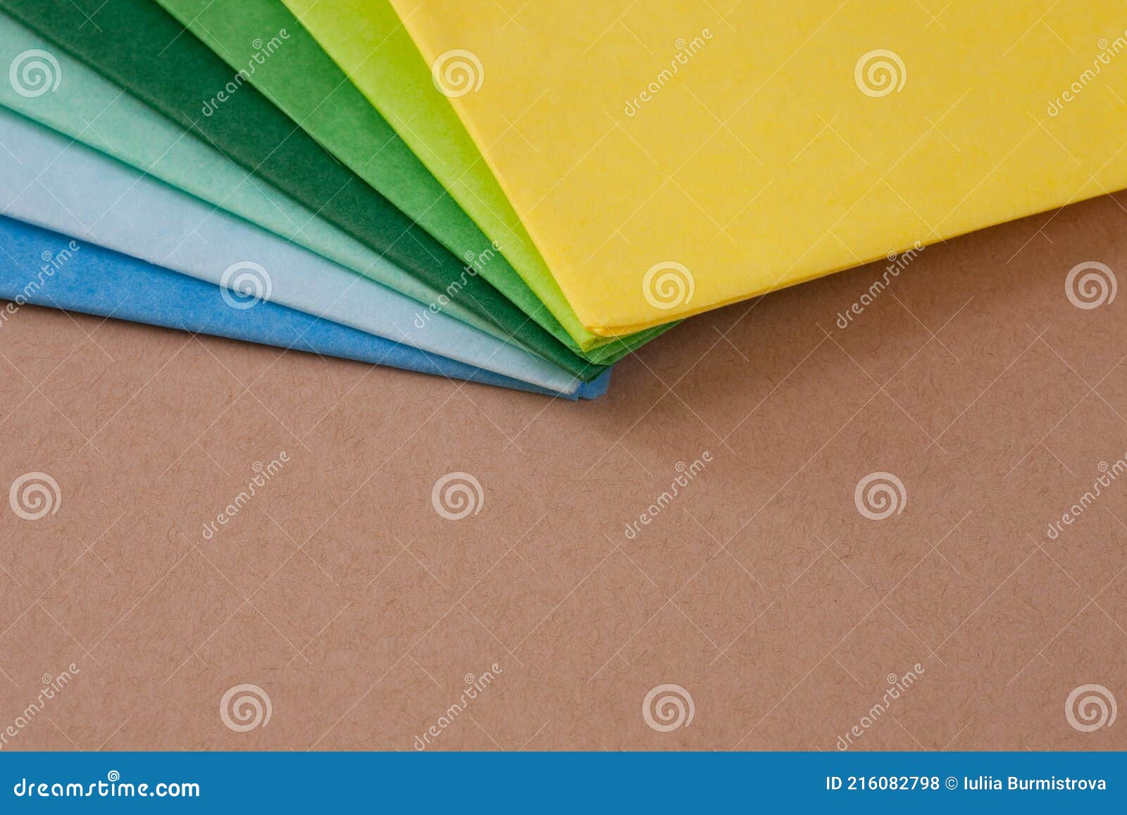 A Stack of Multi Colored Tissue Paper Spread Out in a Fan on a ...