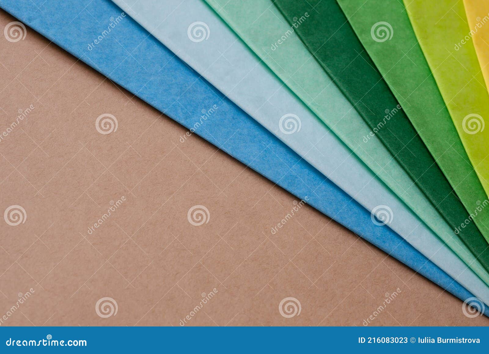 A Stack of Multi Colored Tissue Paper Spread Out in a Fan on a ...