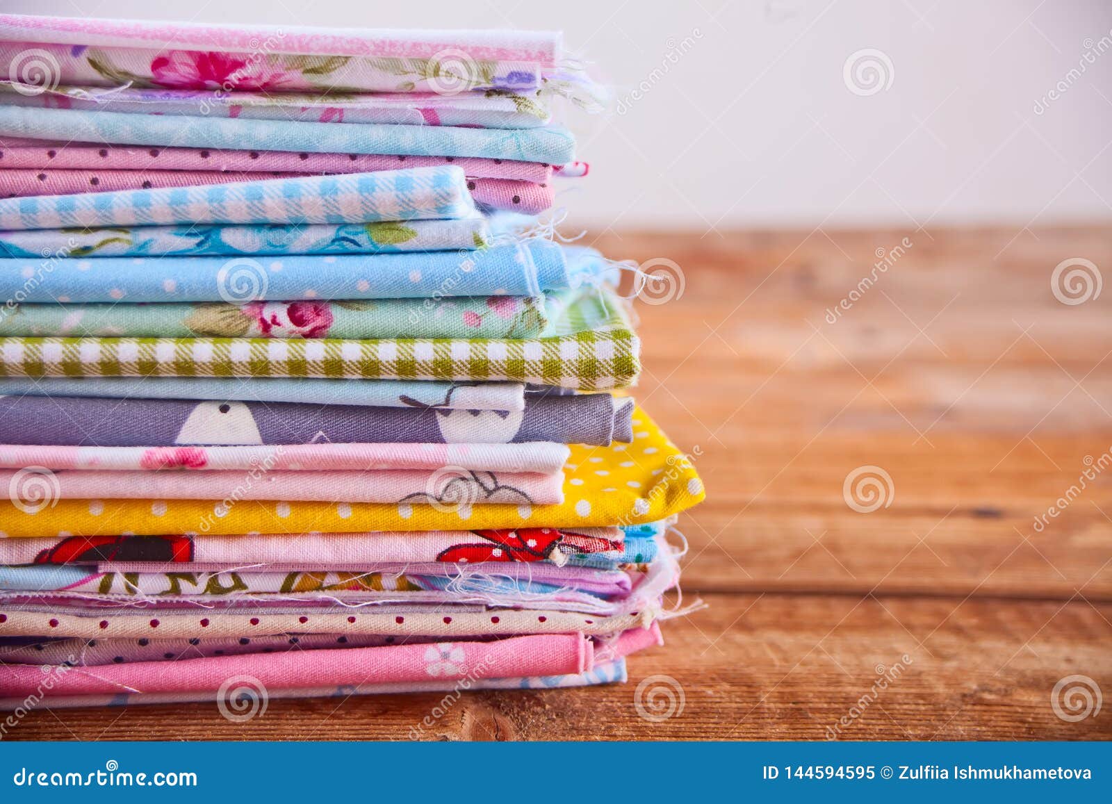 Stack of of New Fabrics in Different Colors Cloth on the Wooden Table ...