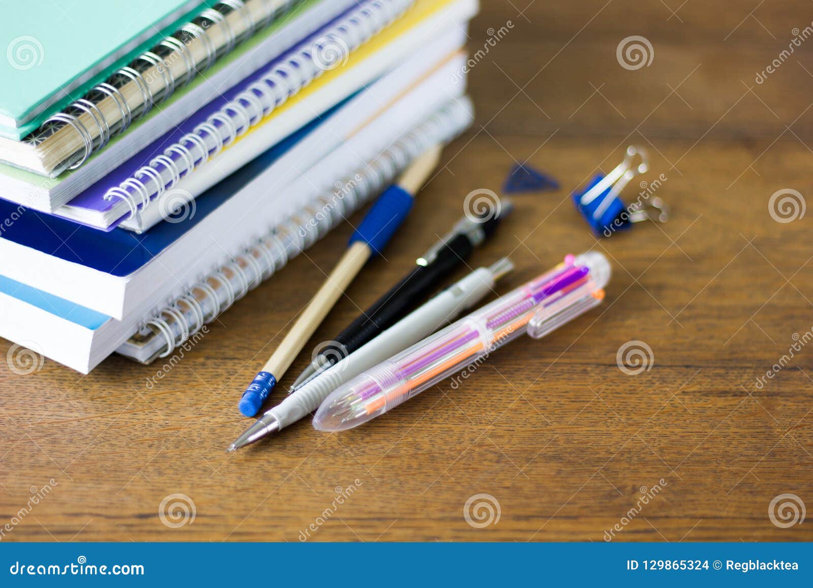 Stack of Notebads and Pens on Wooden Table. Stock Photo - Image of ...