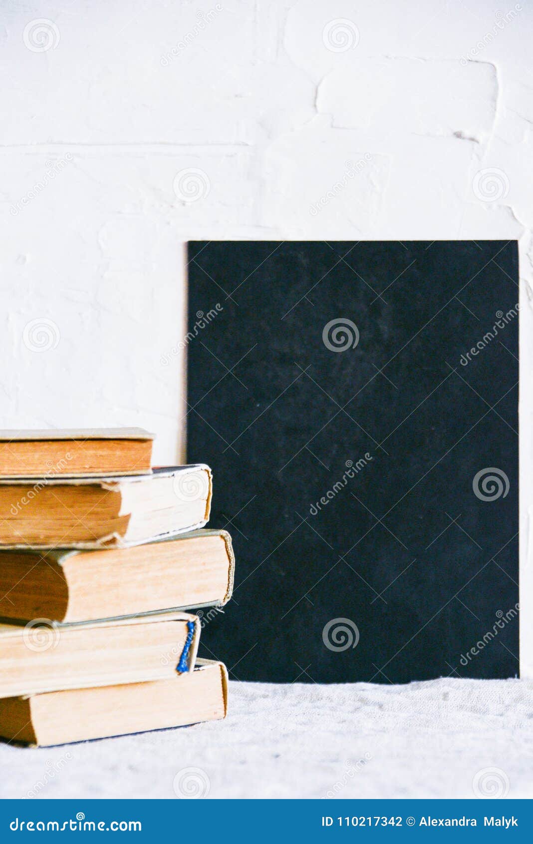 A Stack of Old Battered Books, and Graphite Board for Writing with ...