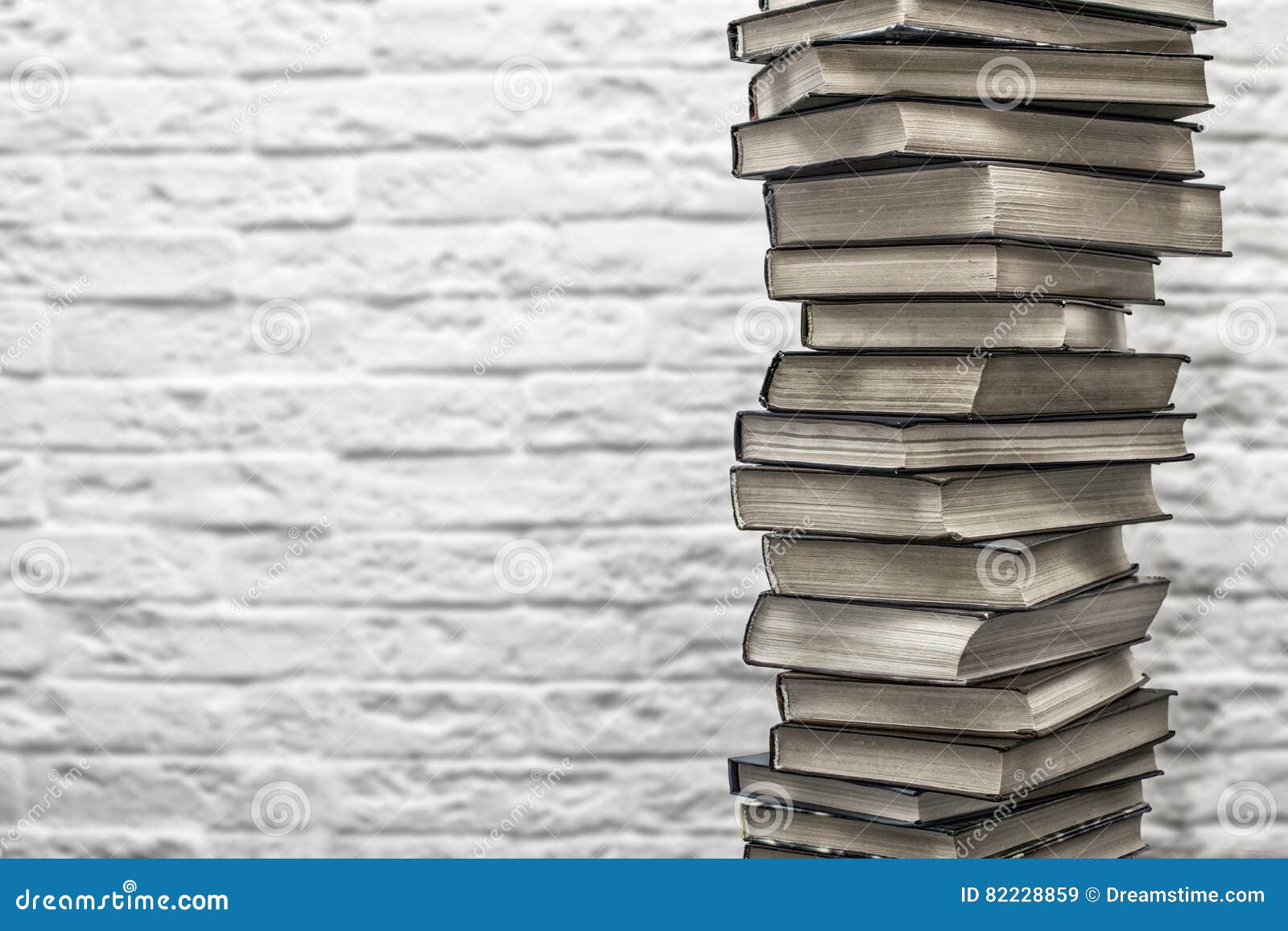 A Stack of Old Books on the Background of Brick Wall Stock Image ...