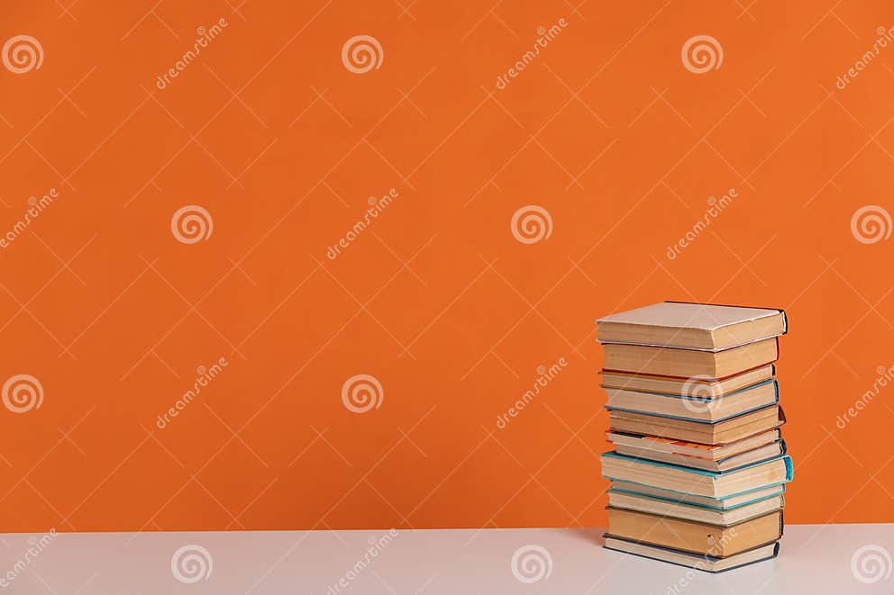Stack of Old Books for College Library on Orange Background Stock Photo ...