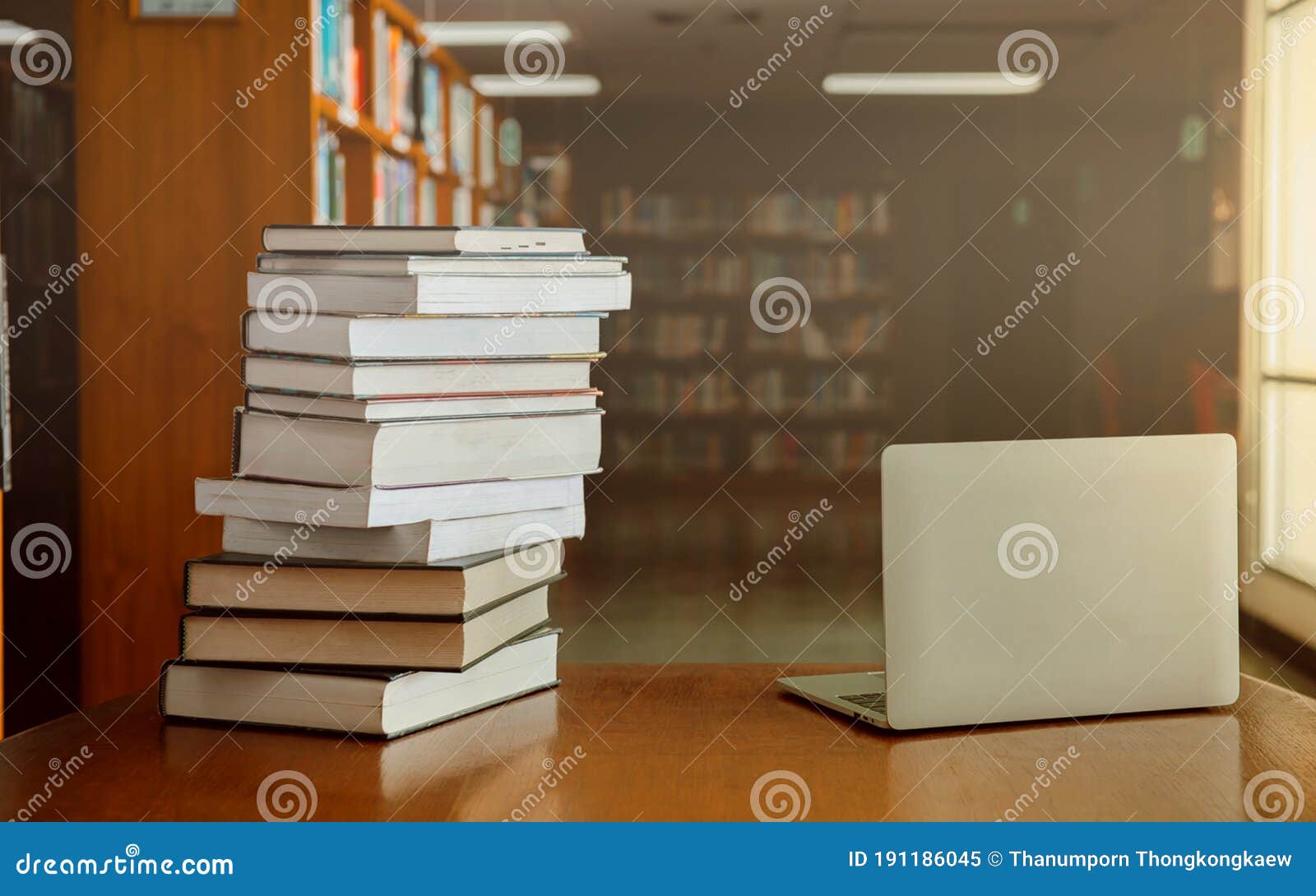 Stack of Old Books and Laptop Computer on Desk in Library Background ...