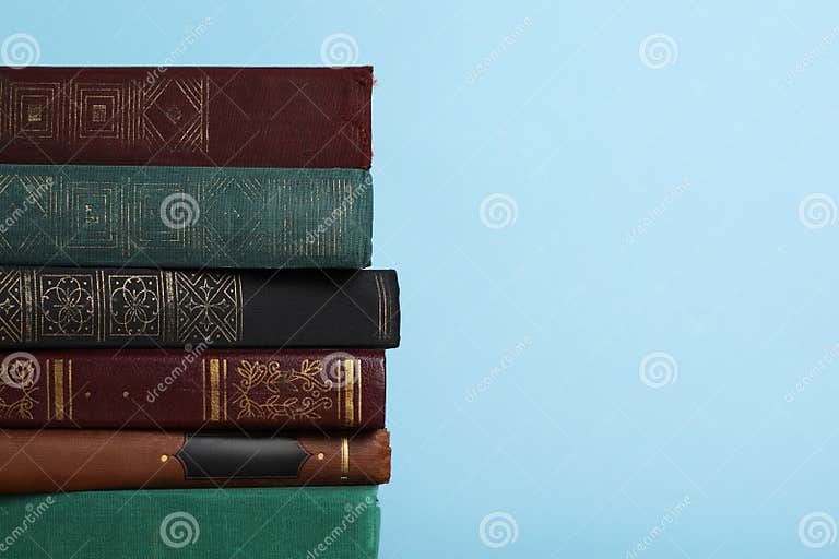 Stack of Old Books on Light Blue Background, Space for Text Stock Image ...