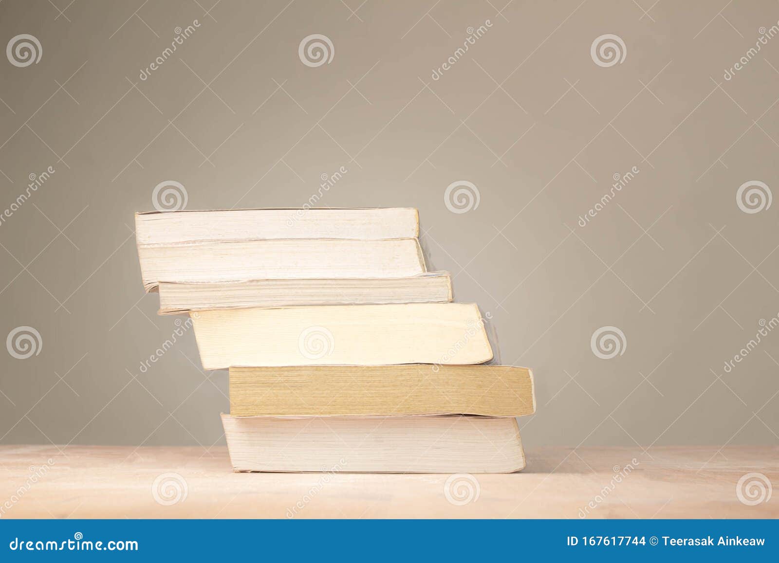 A Stack of Old Books Resting on a Dusty Desk in Room Stock Photo ...