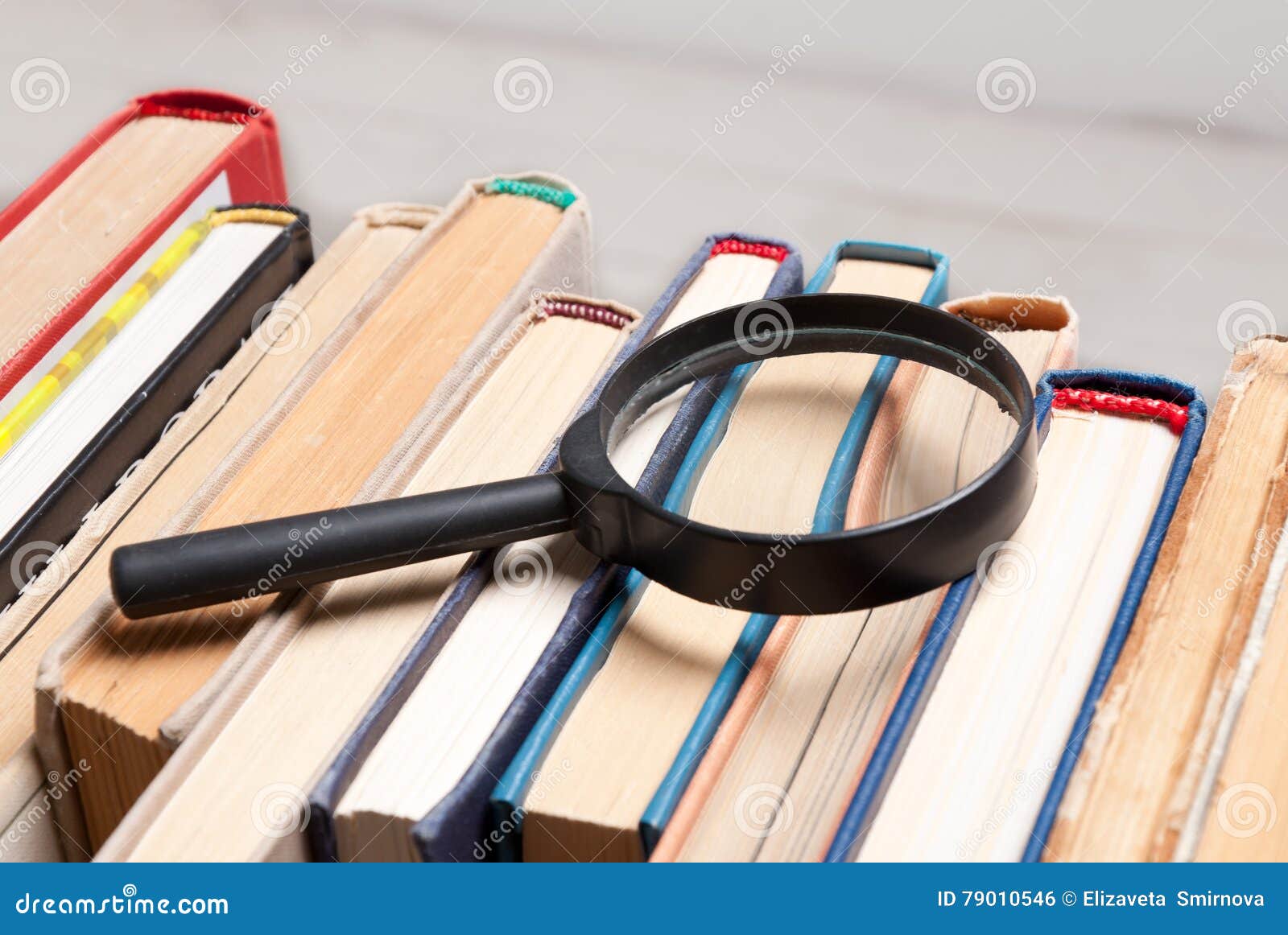 Stack of Old Hardback Books with Magnifying Glass. Search for Relevant ...