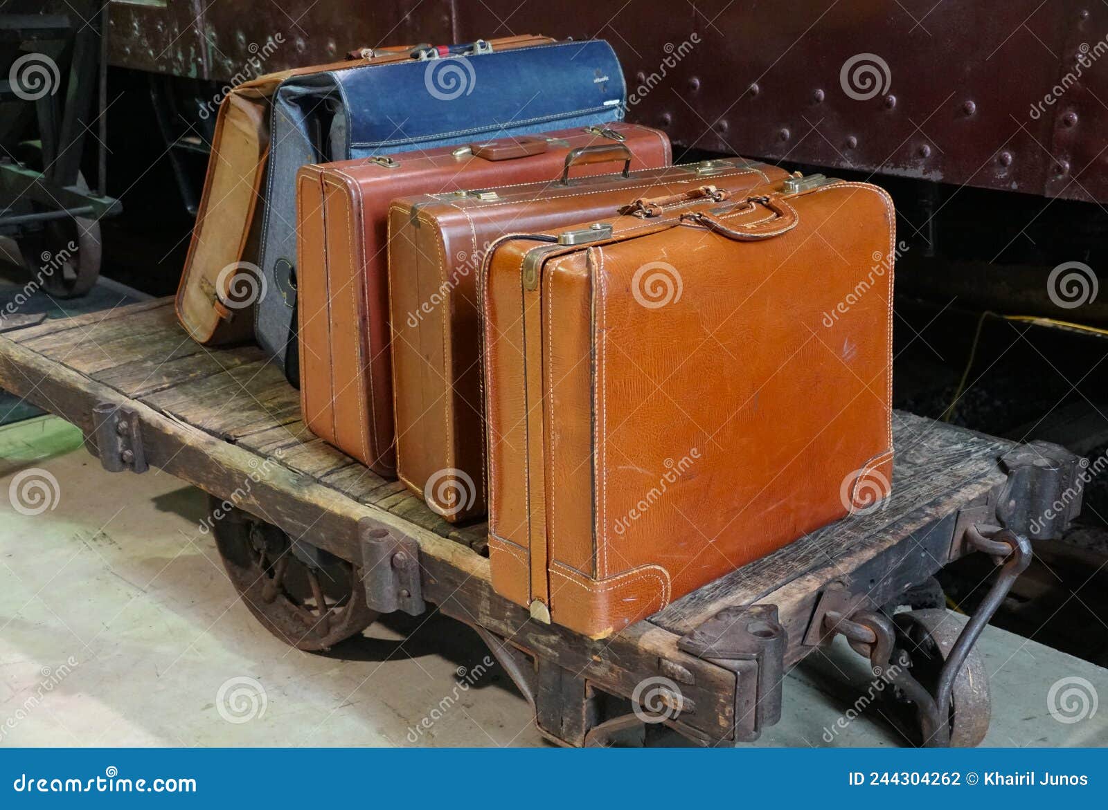 A Stack of Old Luggage on a Wooden Baggage Cart Stock Photo - Image of ...
