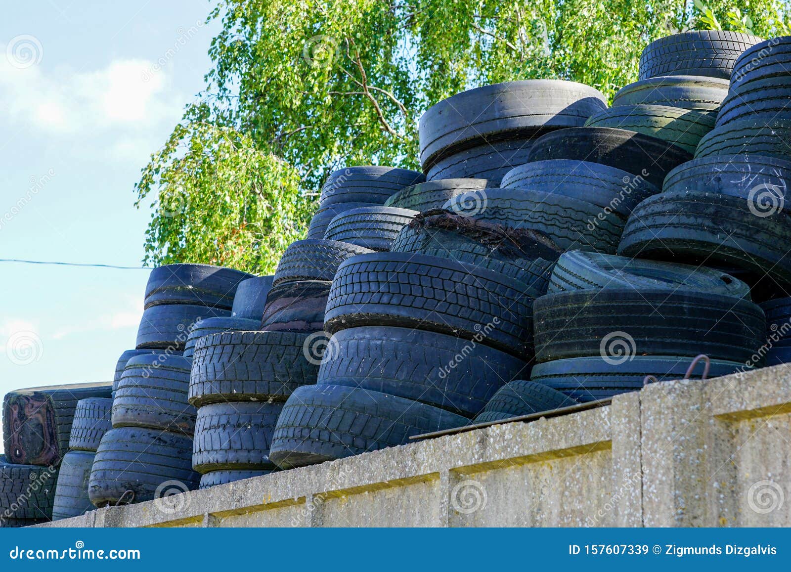 Stack of Old Worn Tires on a Background of Green Trees Stock Image ...
