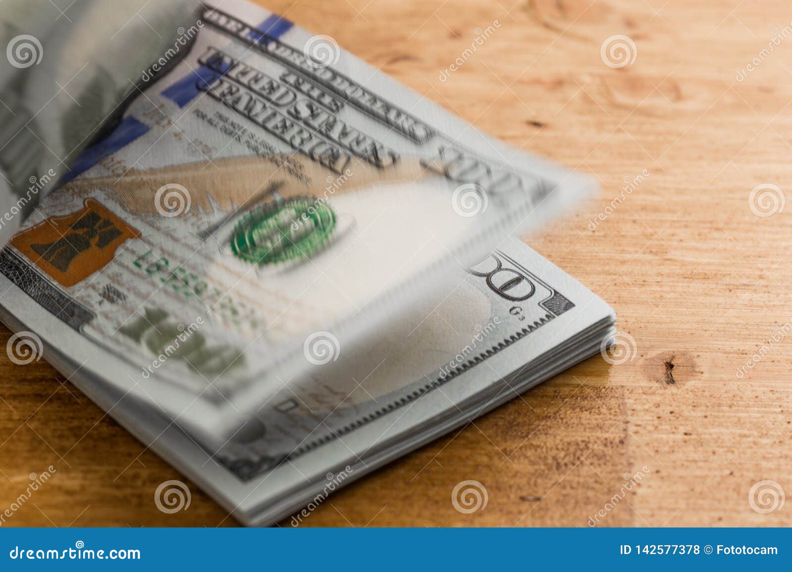 Stack of One Hundred Dollar Bills on a Wooden Table Stock Photo - Image ...