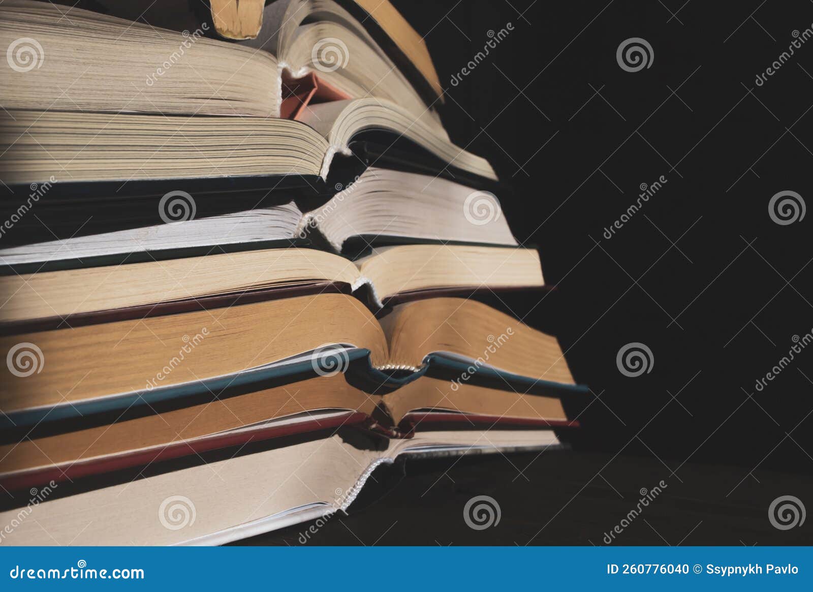 A Stack of Open Books in the Dark. Lots of Books on a Dark Background ...