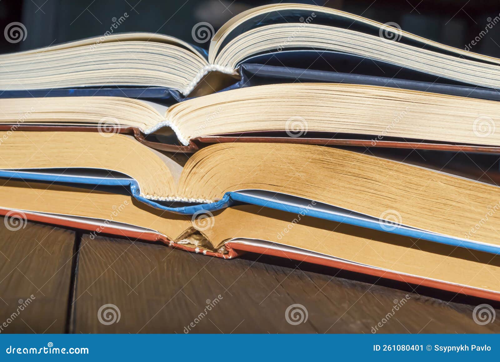 A Stack of Open Books on a Wooden Table. Side View of the Books. on the ...