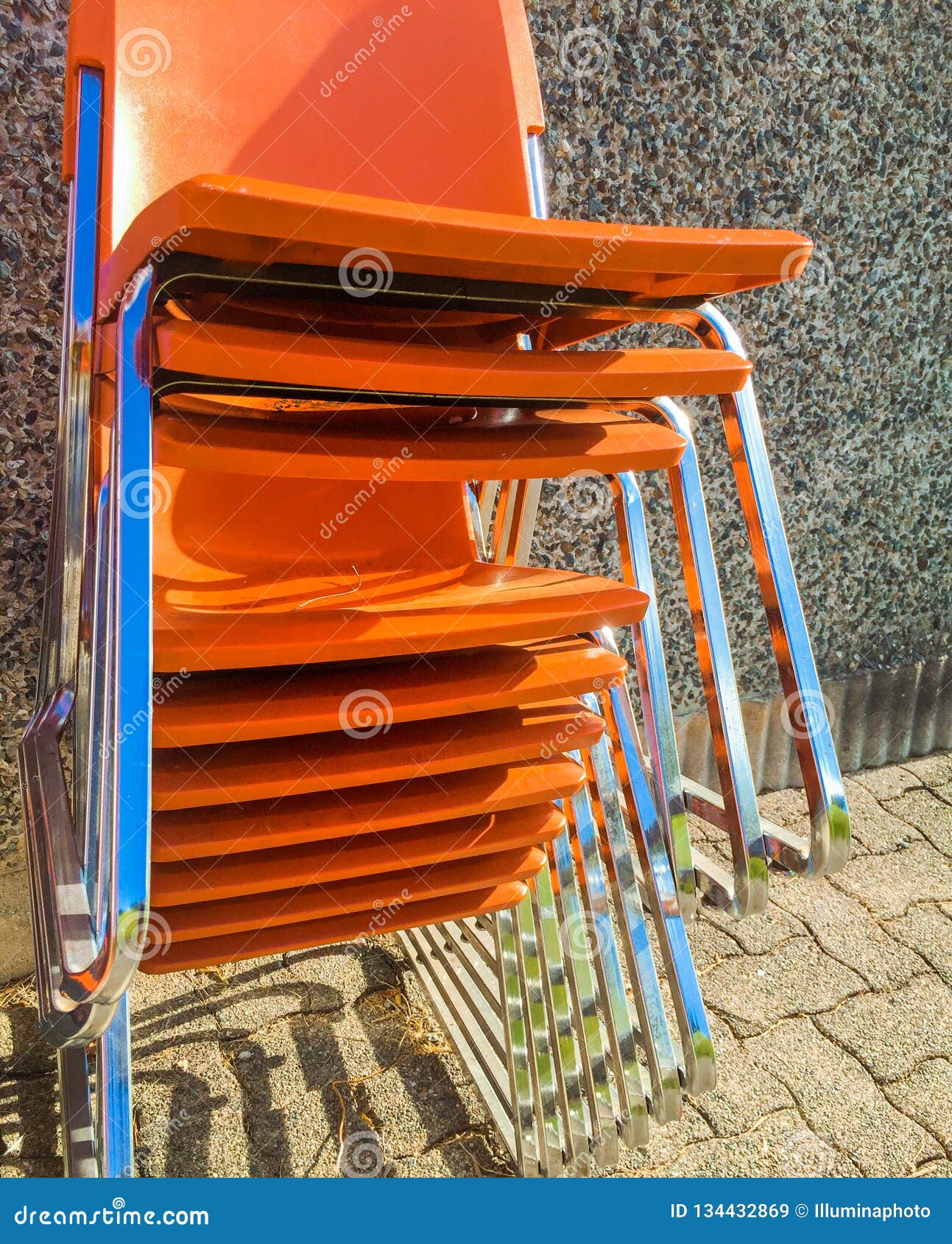 Stack of Orange Plastic Modern Chairs Outside. Stock Image - Image of ...